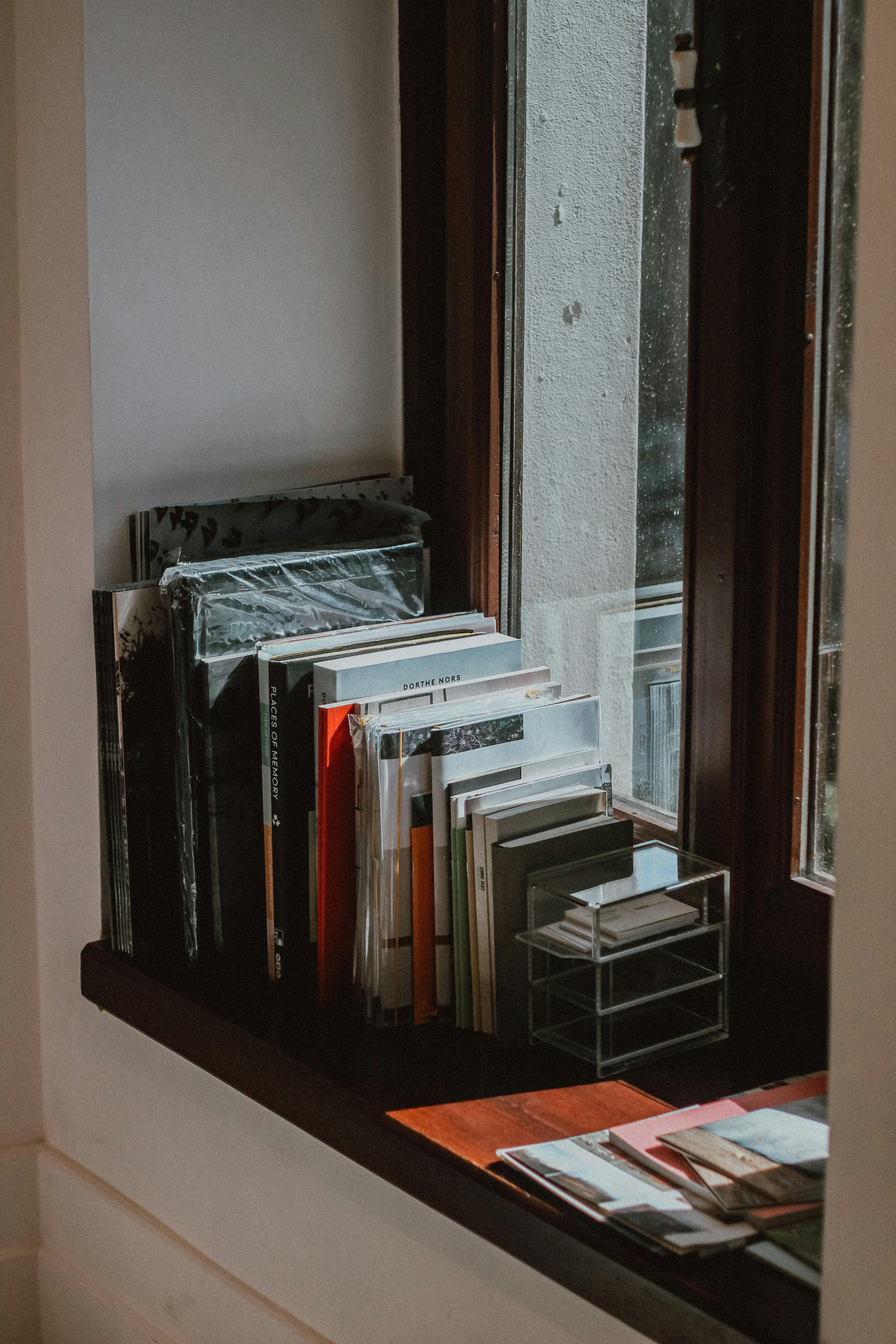 Photo of Books and Notebooks Lying on a Black Window Sill · Free Stock ...