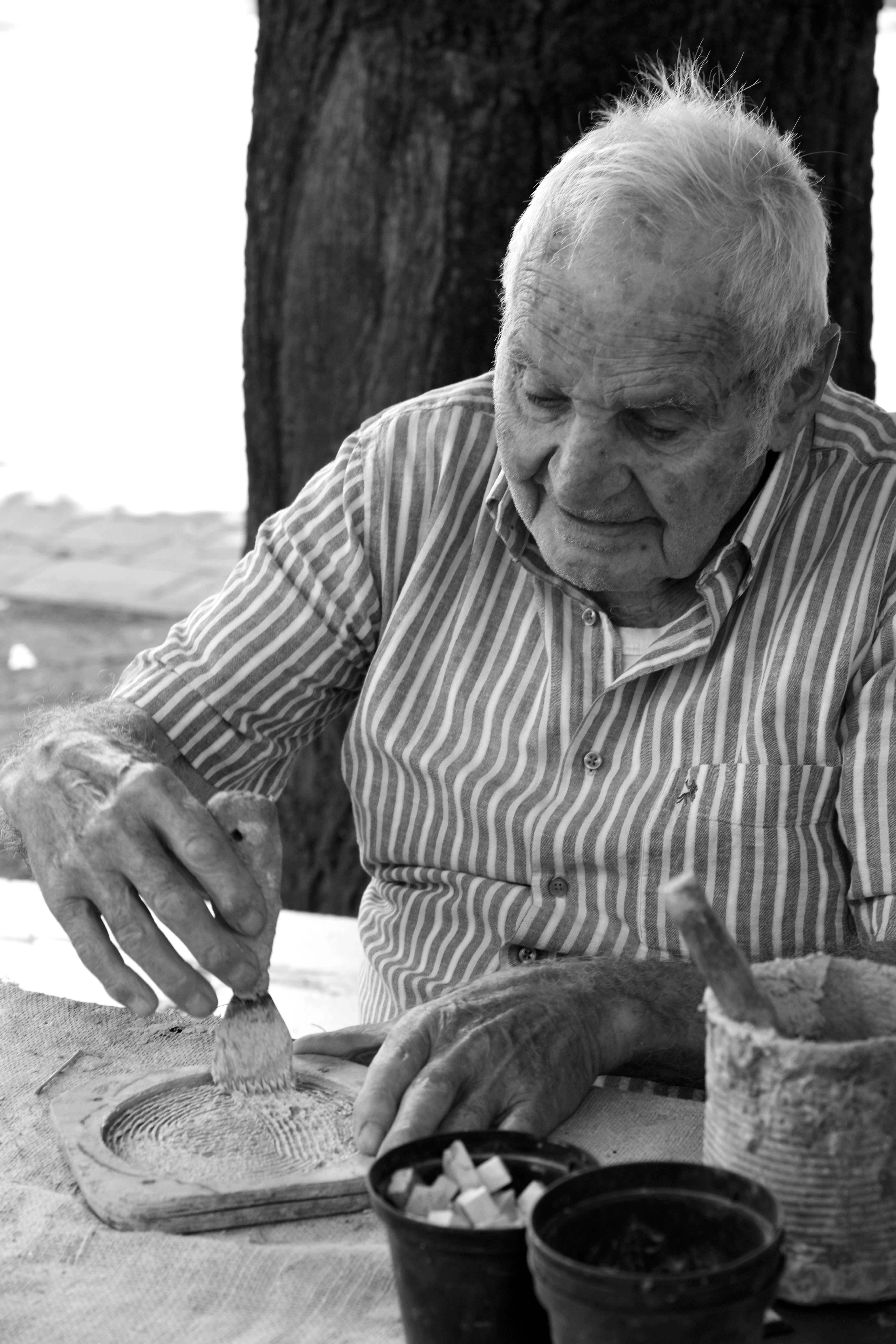 Monochrome Photo of an Old Man doing Crafts · Free Stock Photo
