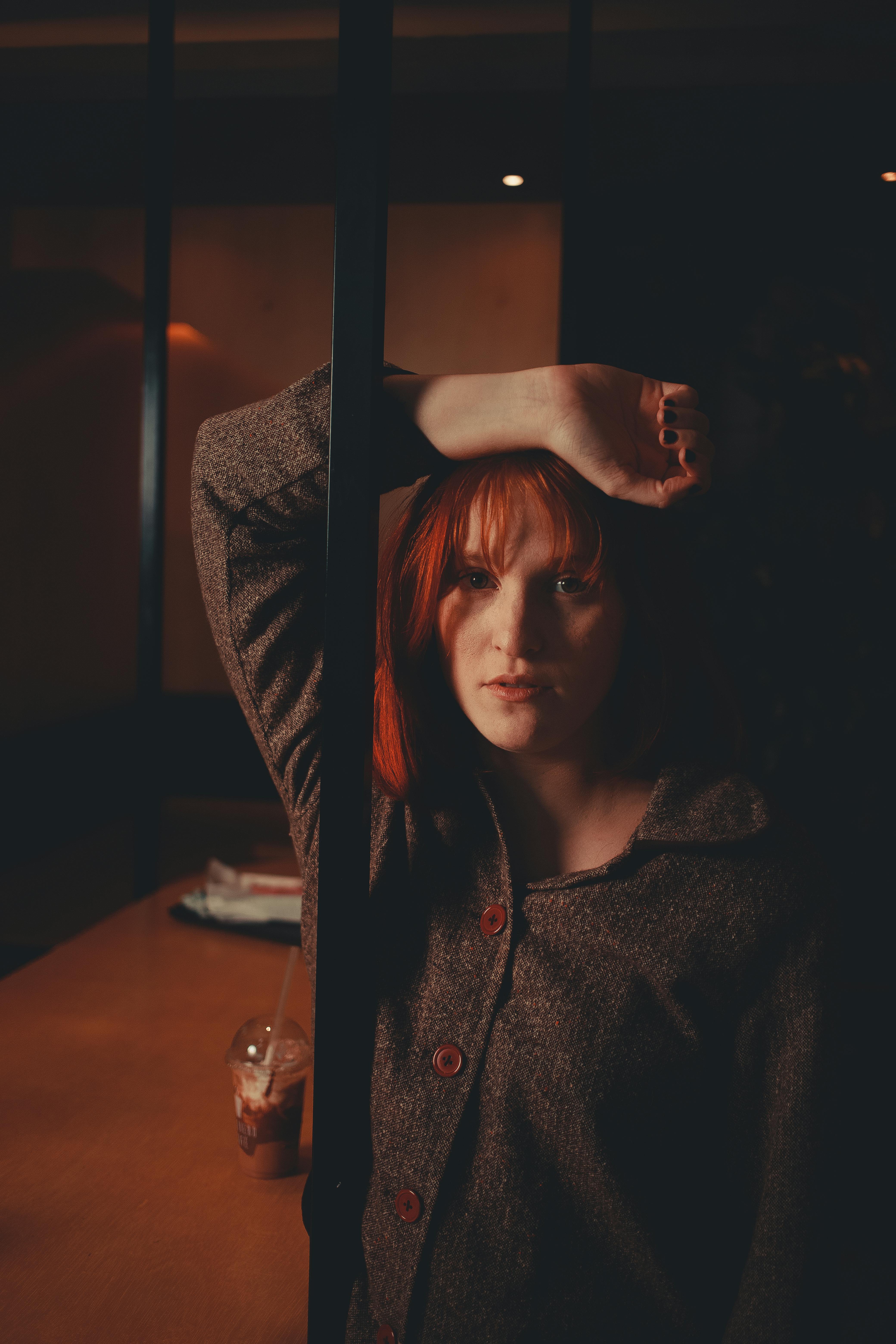 Photo of a Standing Woman with a Hand Raised · Free Stock Photo