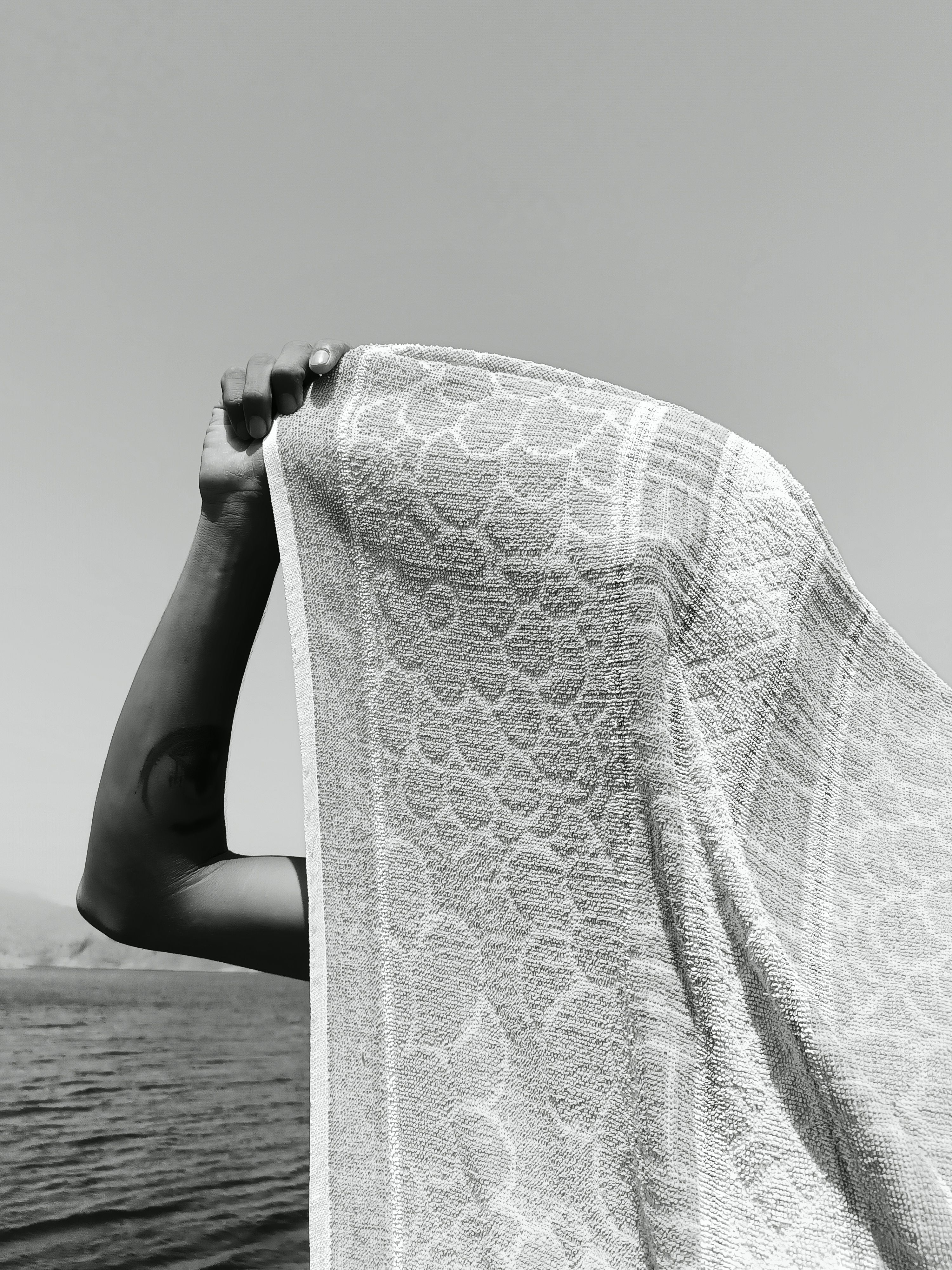Monochrome Photo of Person holding a Towel · Free Stock Photo
