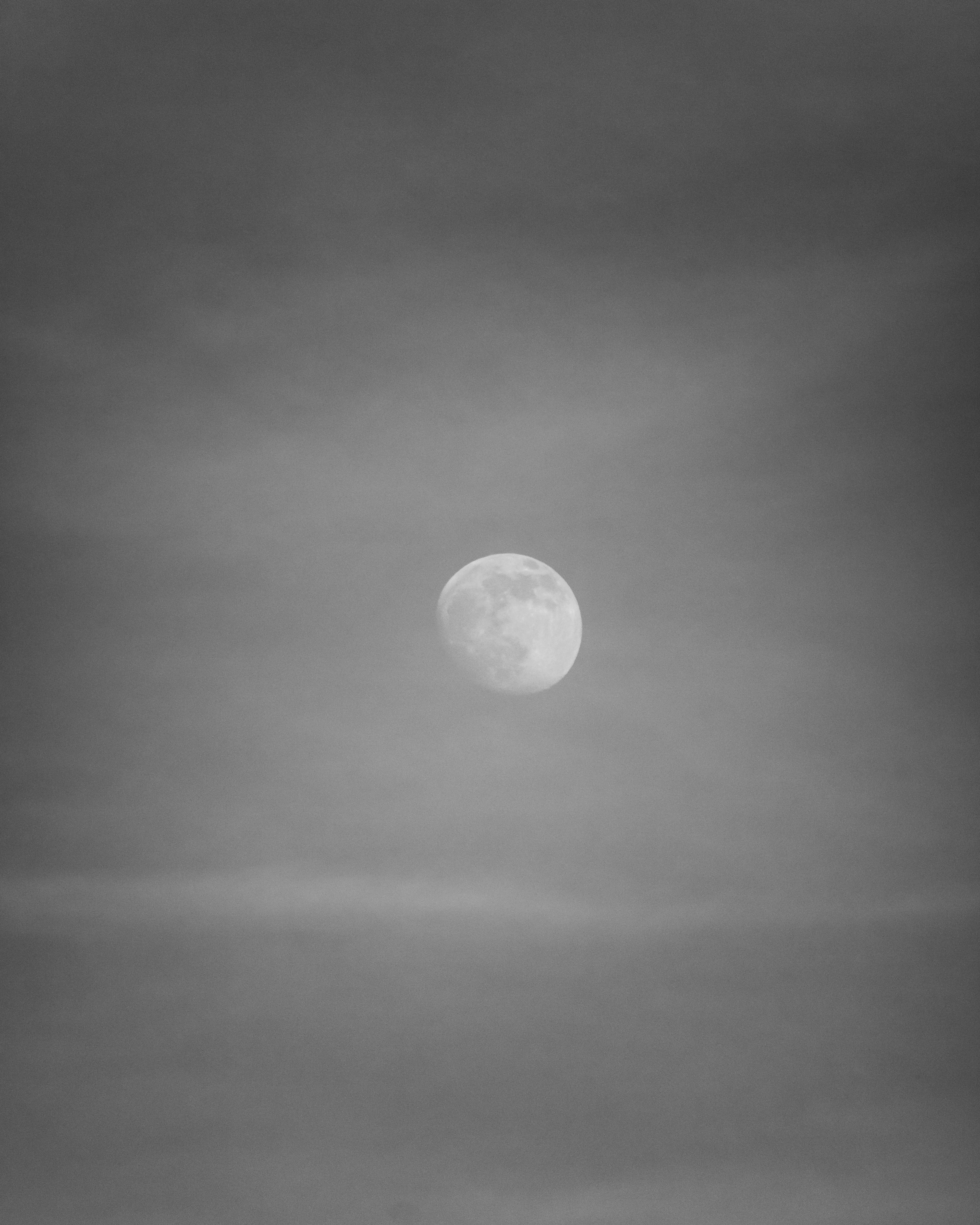 Grayscale Photo of the Moon in the Sky · Free Stock Photo