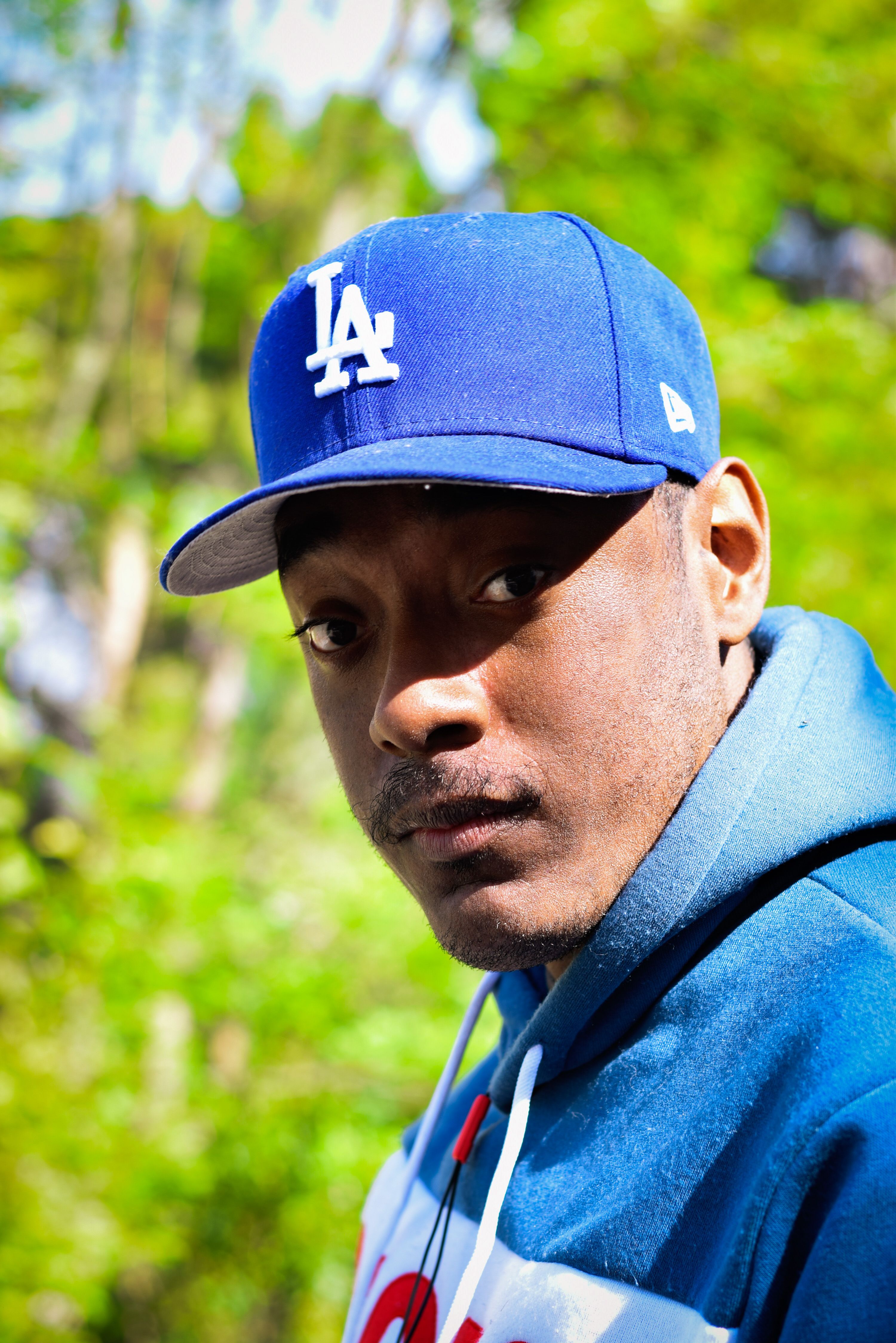 A Man in Blue Cap and Blue Hoodie · Free Stock Photo