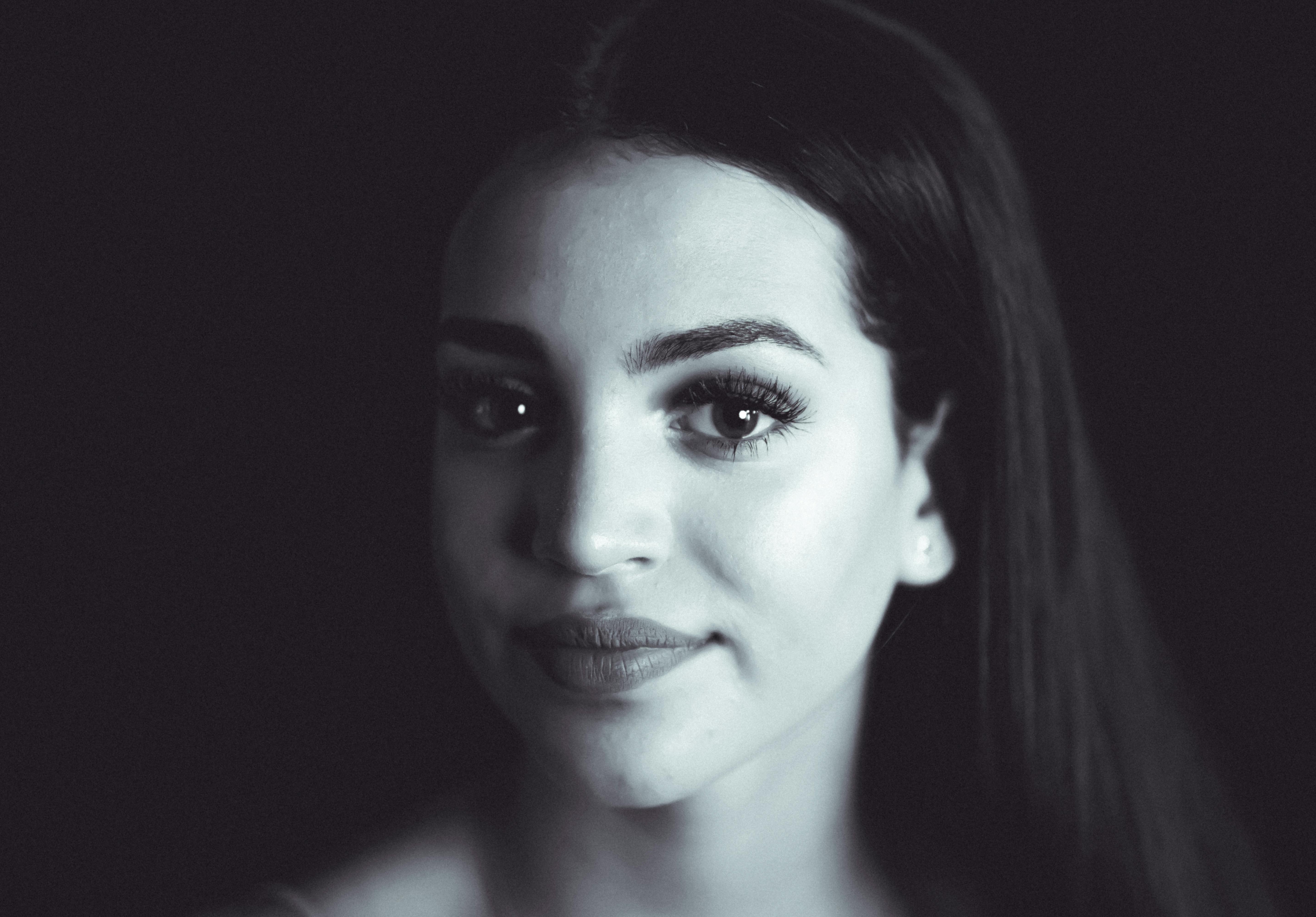 A Grayscale Photo of a Smiling Woman · Free Stock Photo