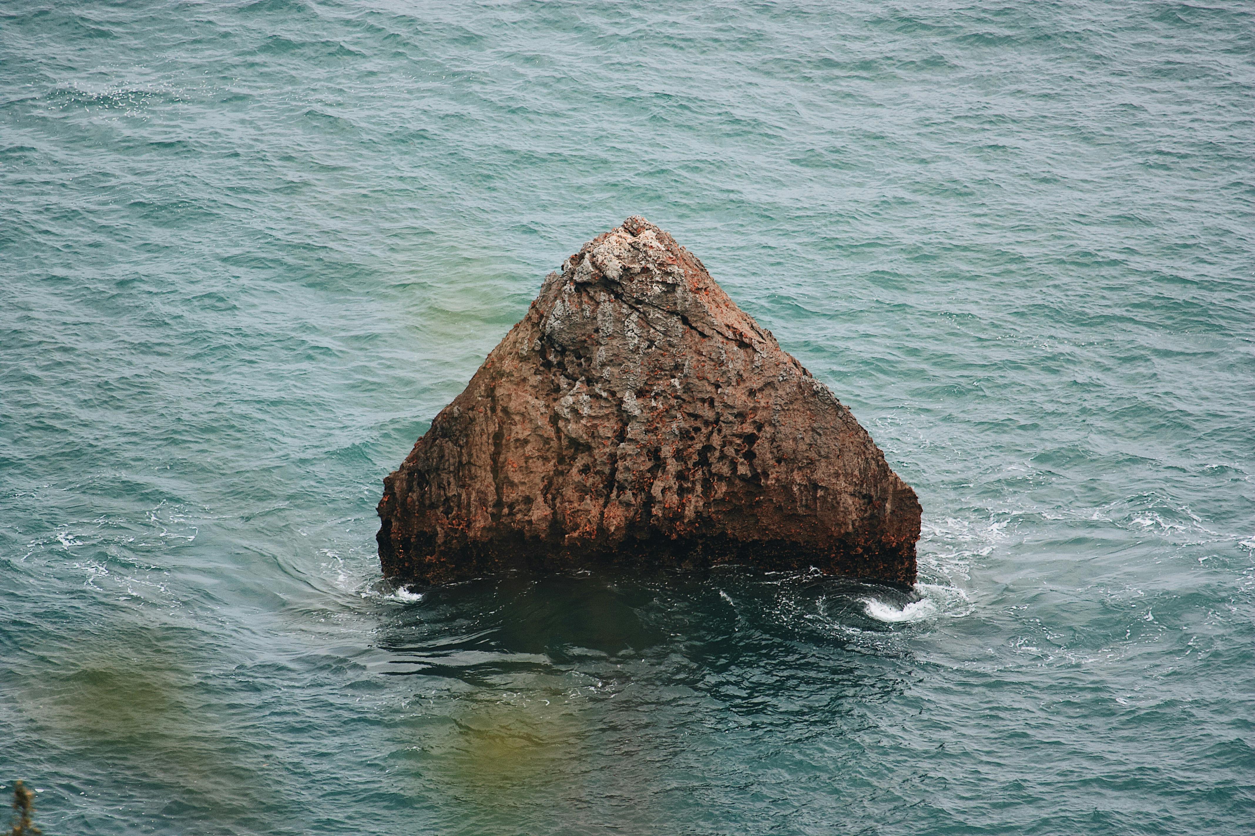 A Rock Formation on the Body of Water · Free Stock Photo
