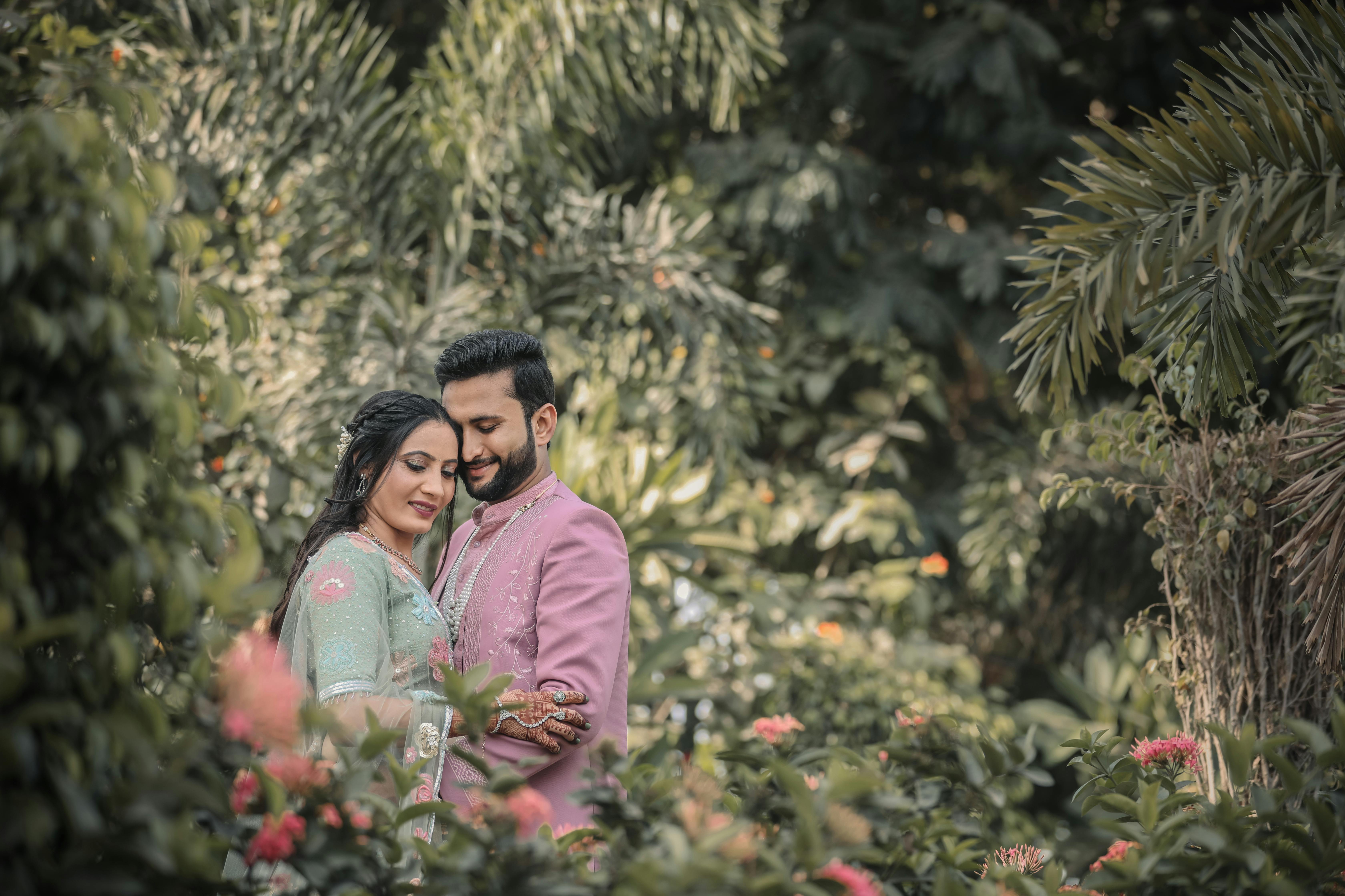 A Man and a Woman Standing Near Green Trees · Free Stock Photo
