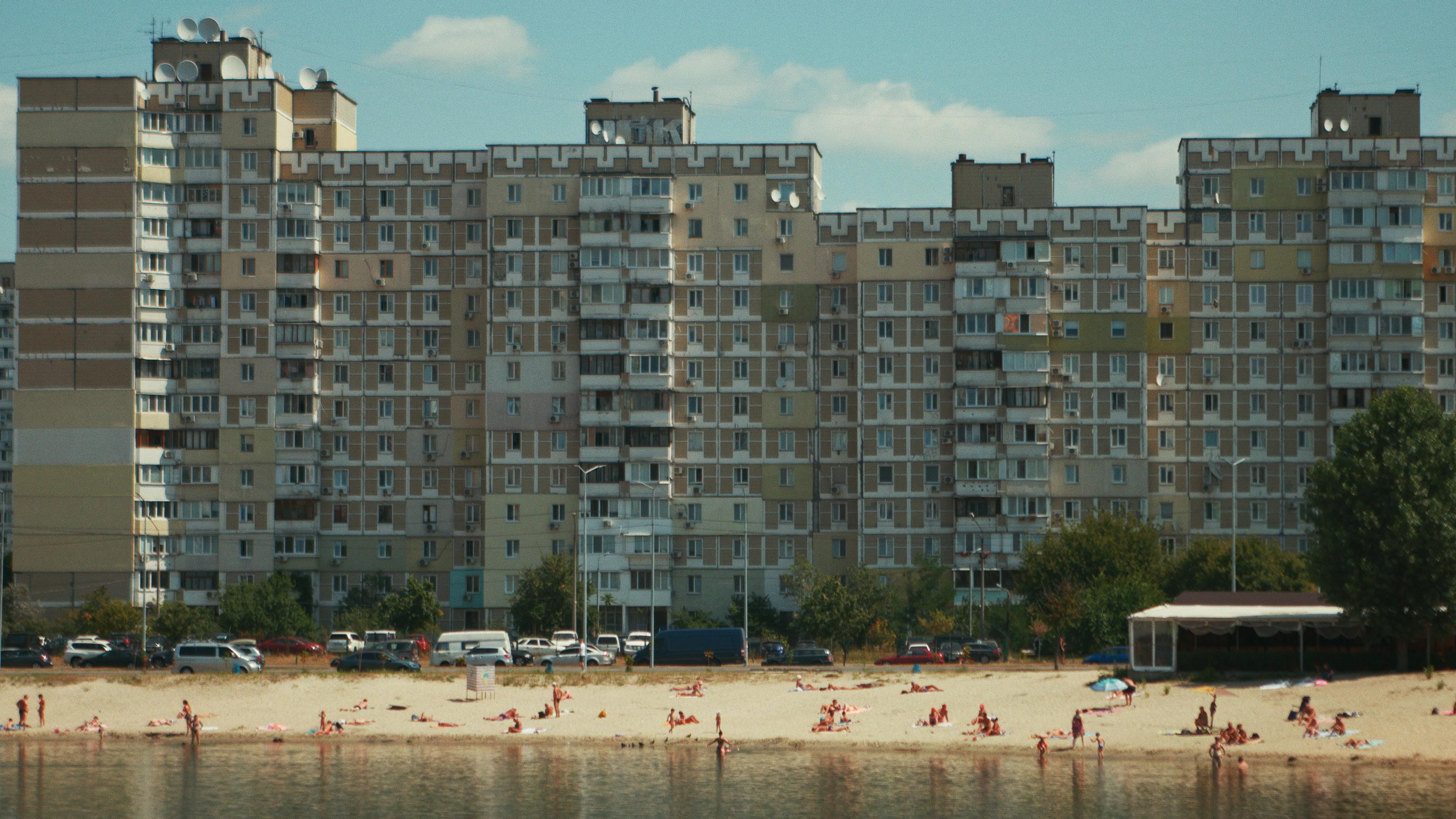 People on Beach Near High Rise Buildings · Free Stock Photo