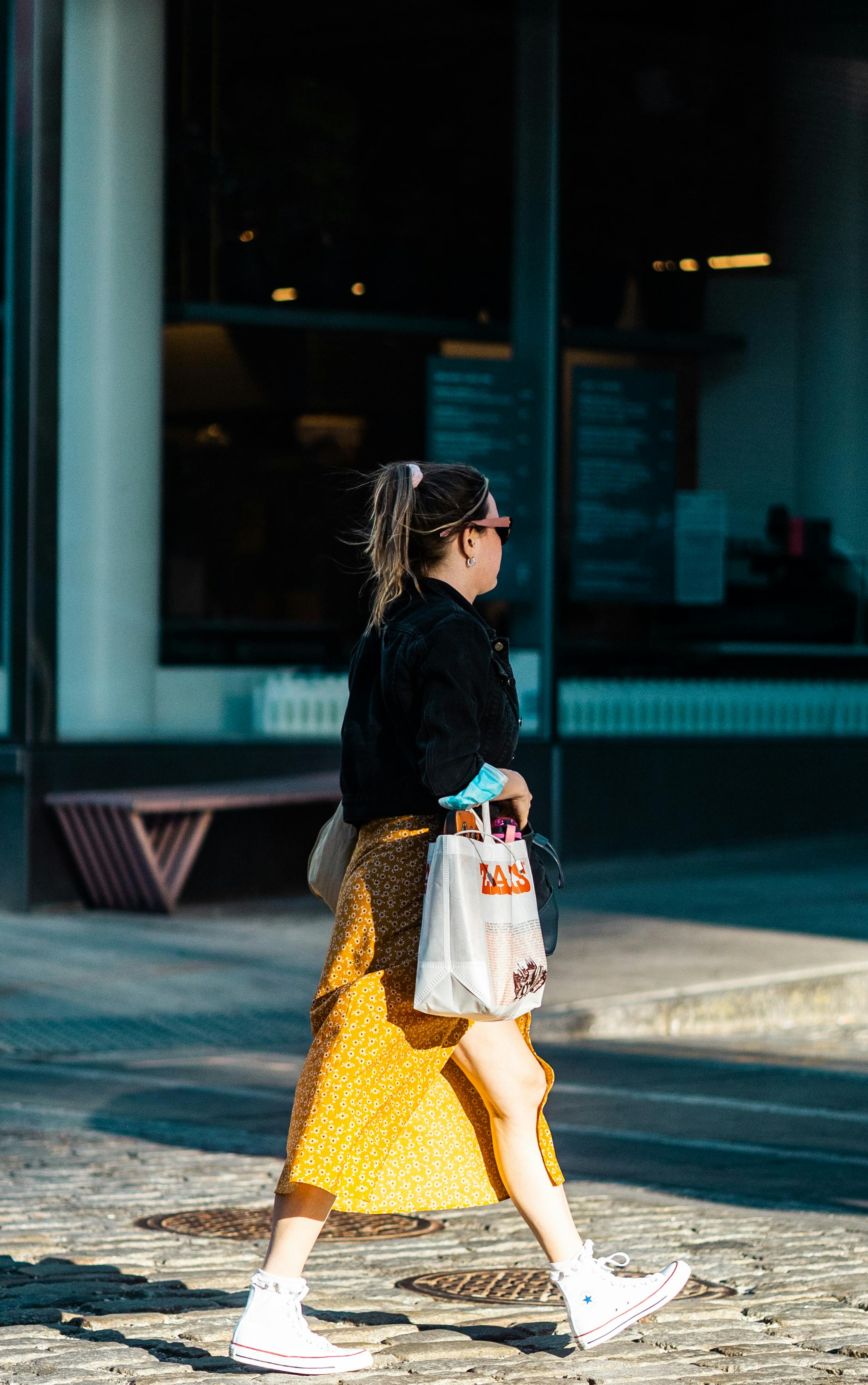 Woman Waring Fur Walking on a Sidewalk · Free Stock Photo