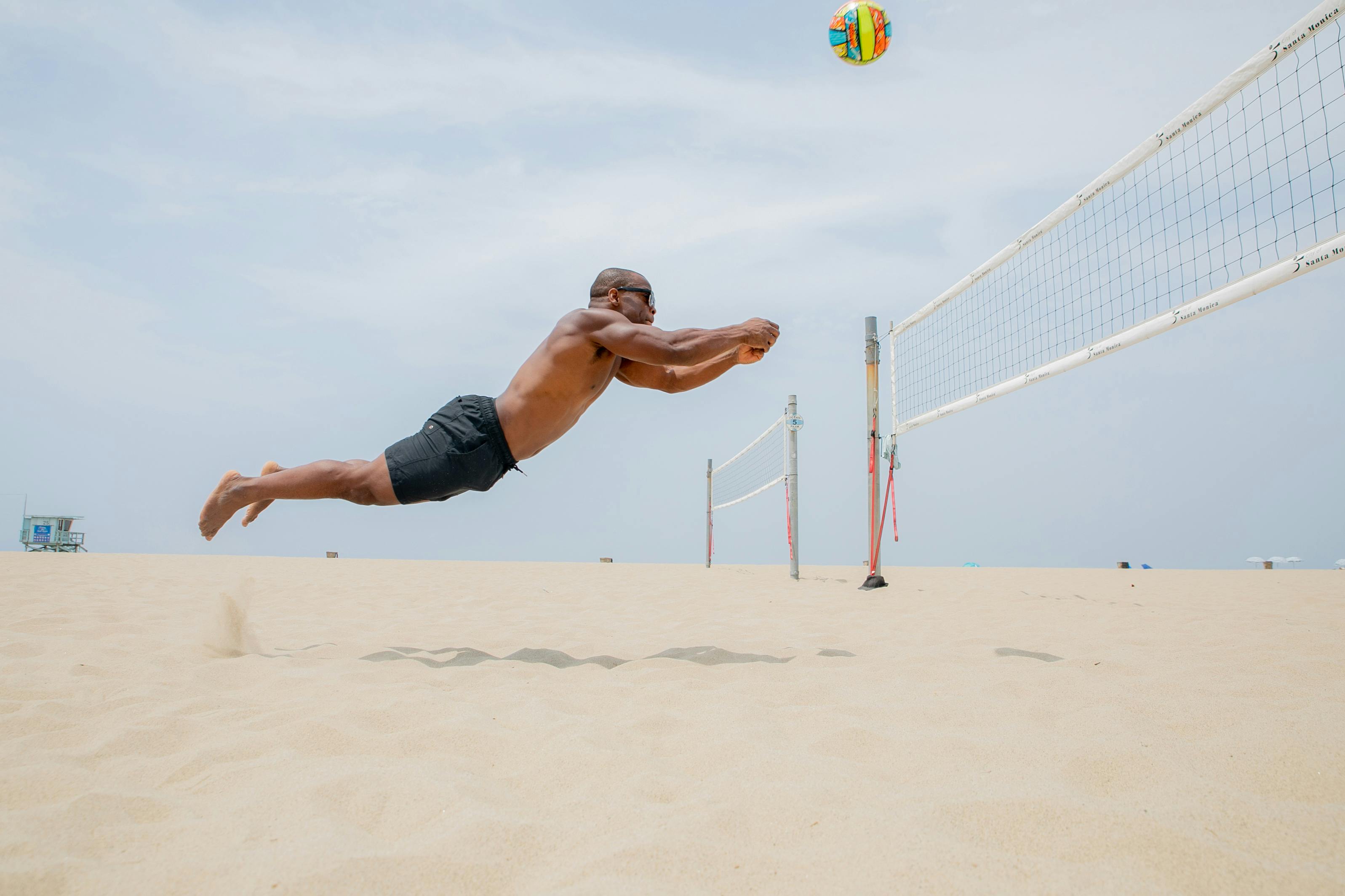 Men Jumping into a Chest Bump on a Beach · Free Stock Photo