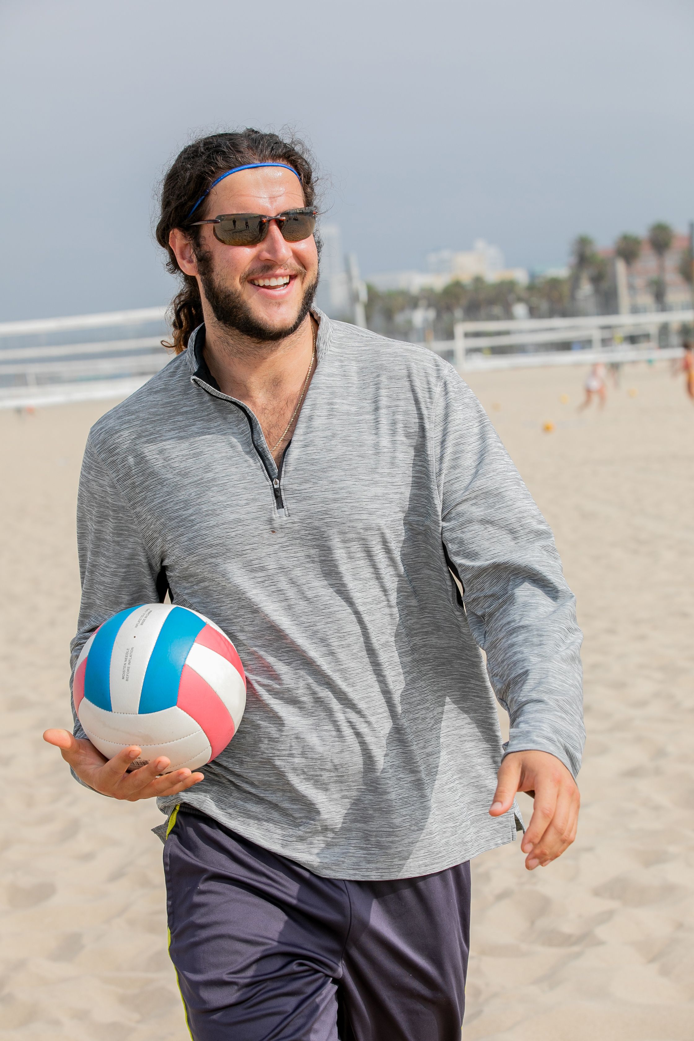 Man Carrying Volleyball Ball · Free Stock Photo