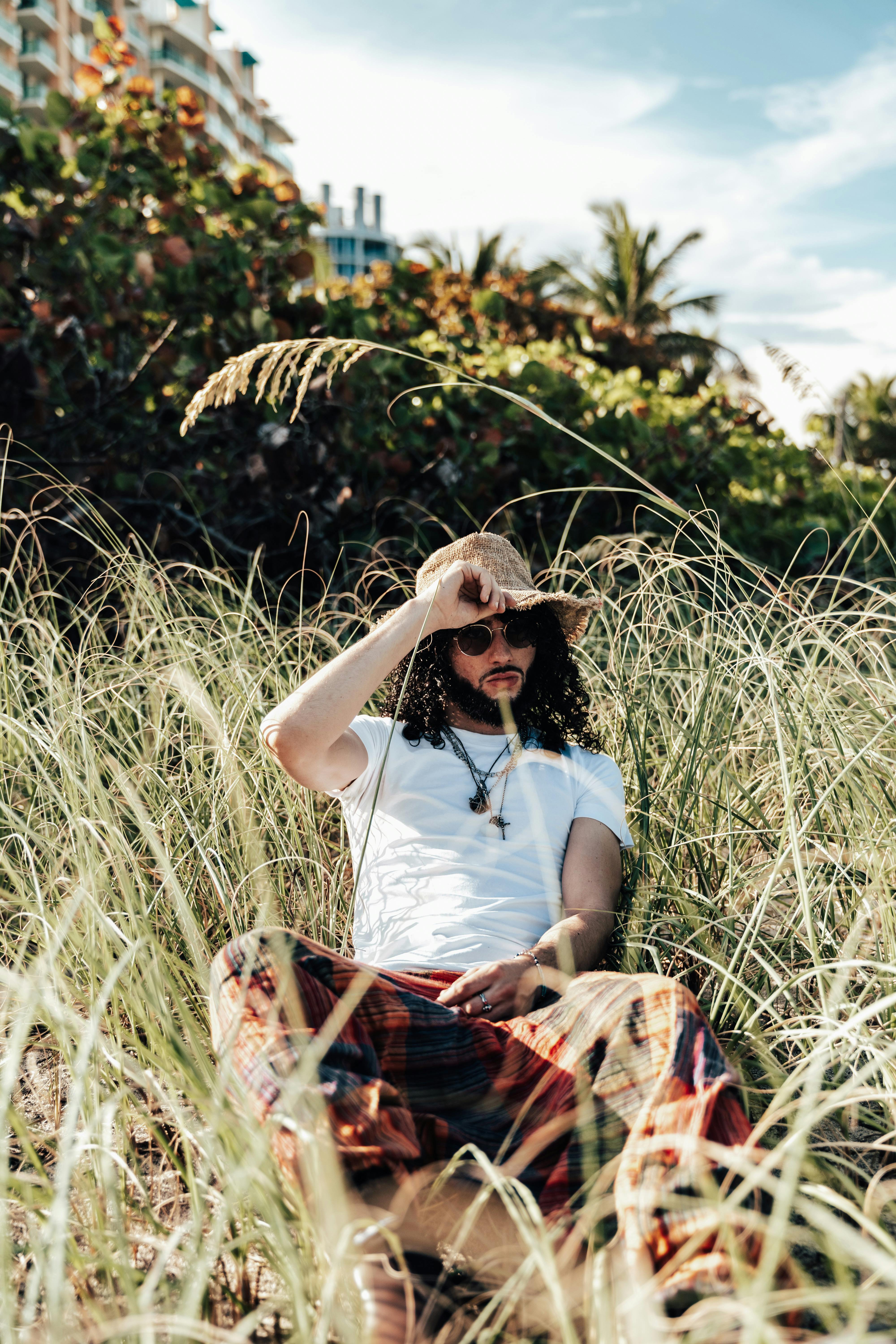 Man Leaning Against Grass in a Field · Free Stock Photo