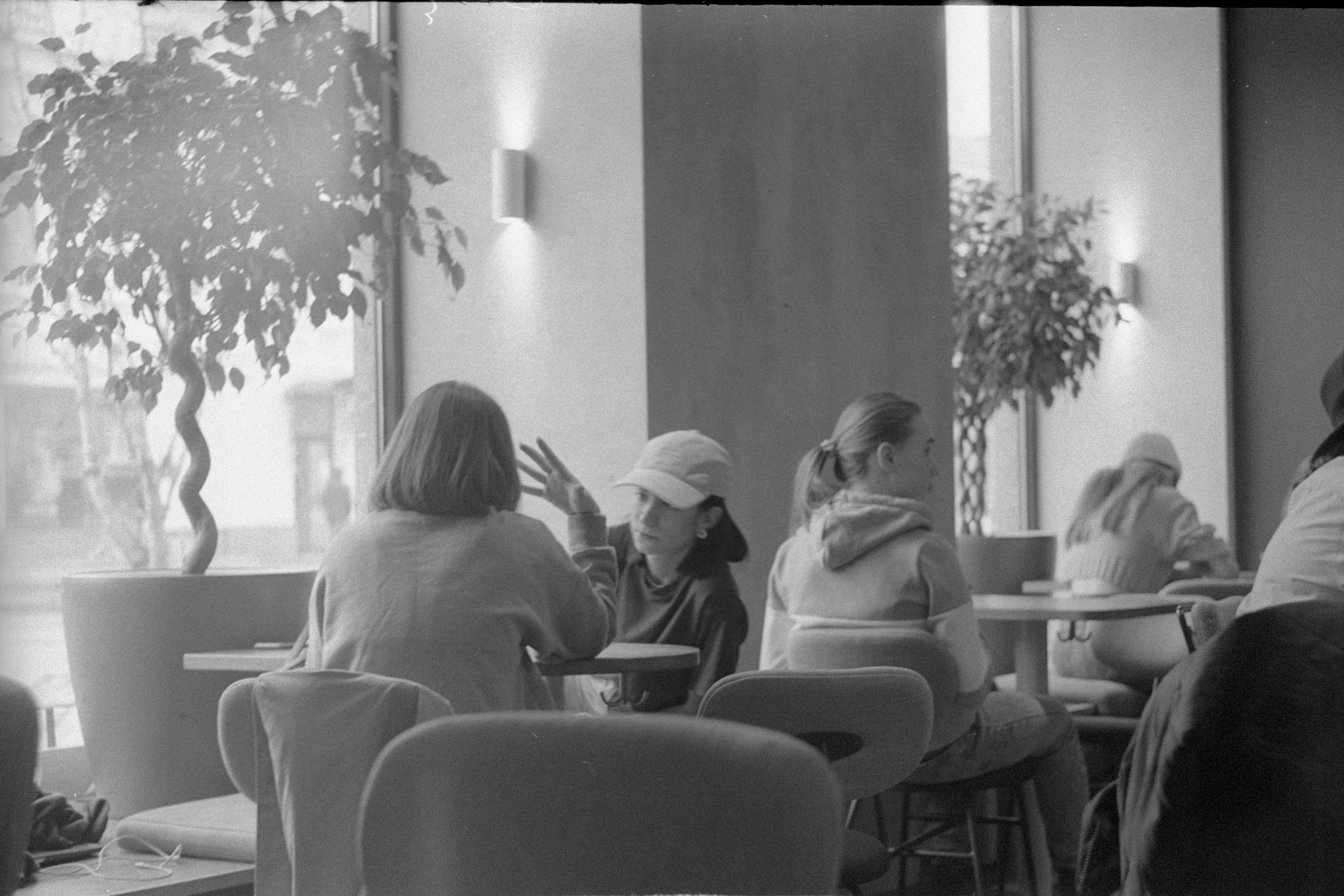 Grayscale Photo of People at a Restaurant · Free Stock Photo