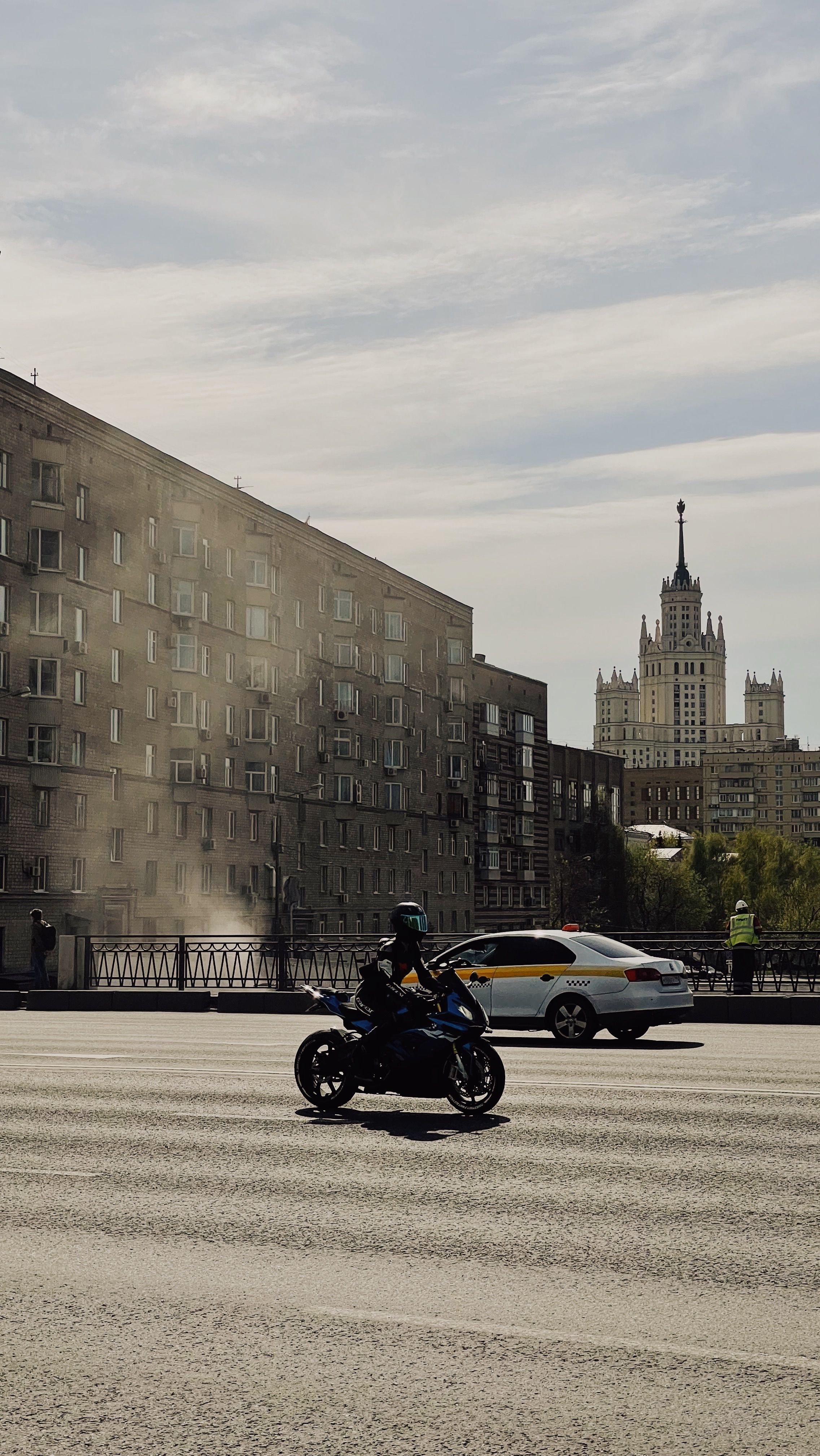 Person Riding a Motorcycle on the Road Near Buildings · Free Stock Photo