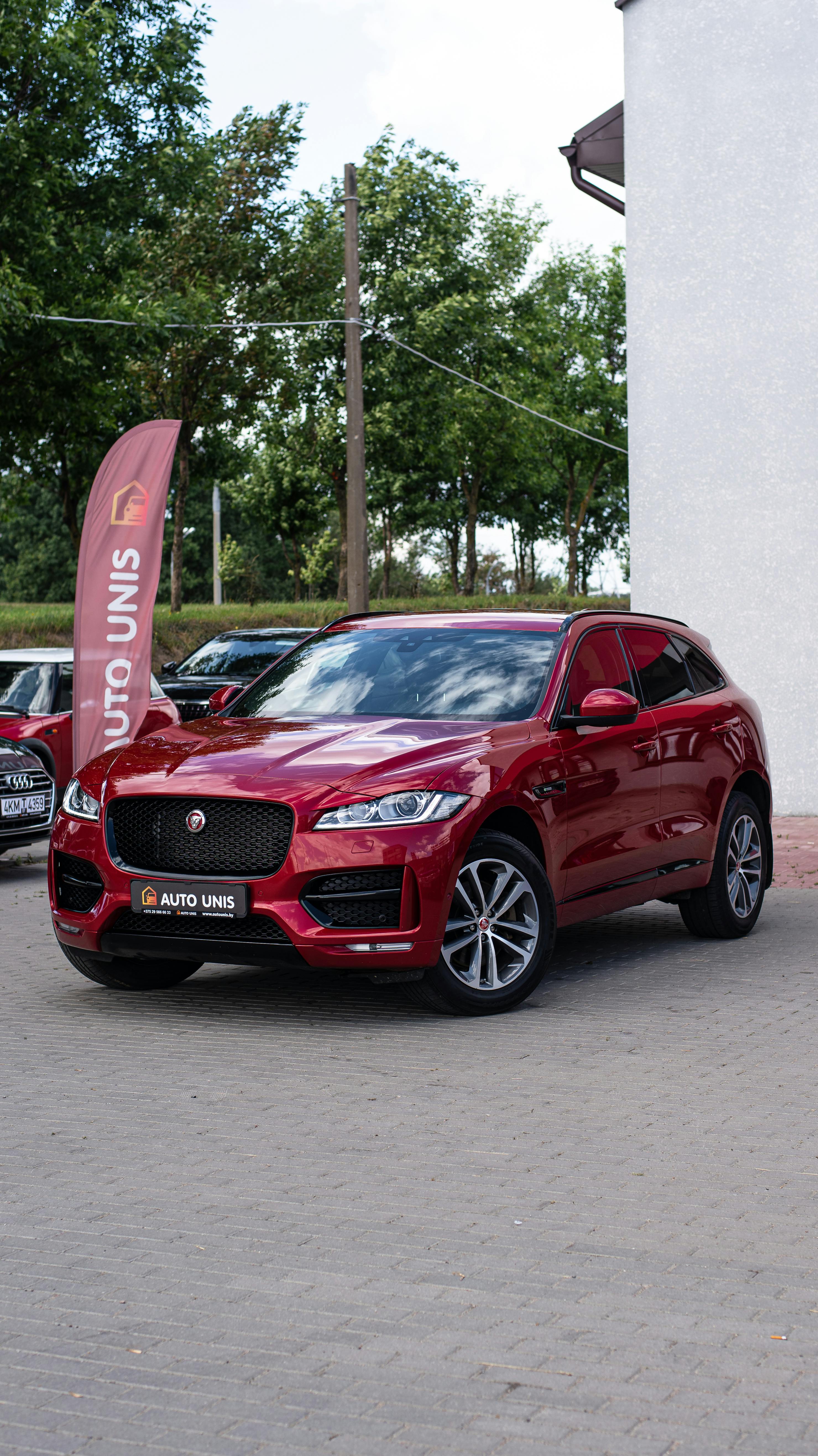Red jaguar Parked Beside the Wall · Free Stock Photo