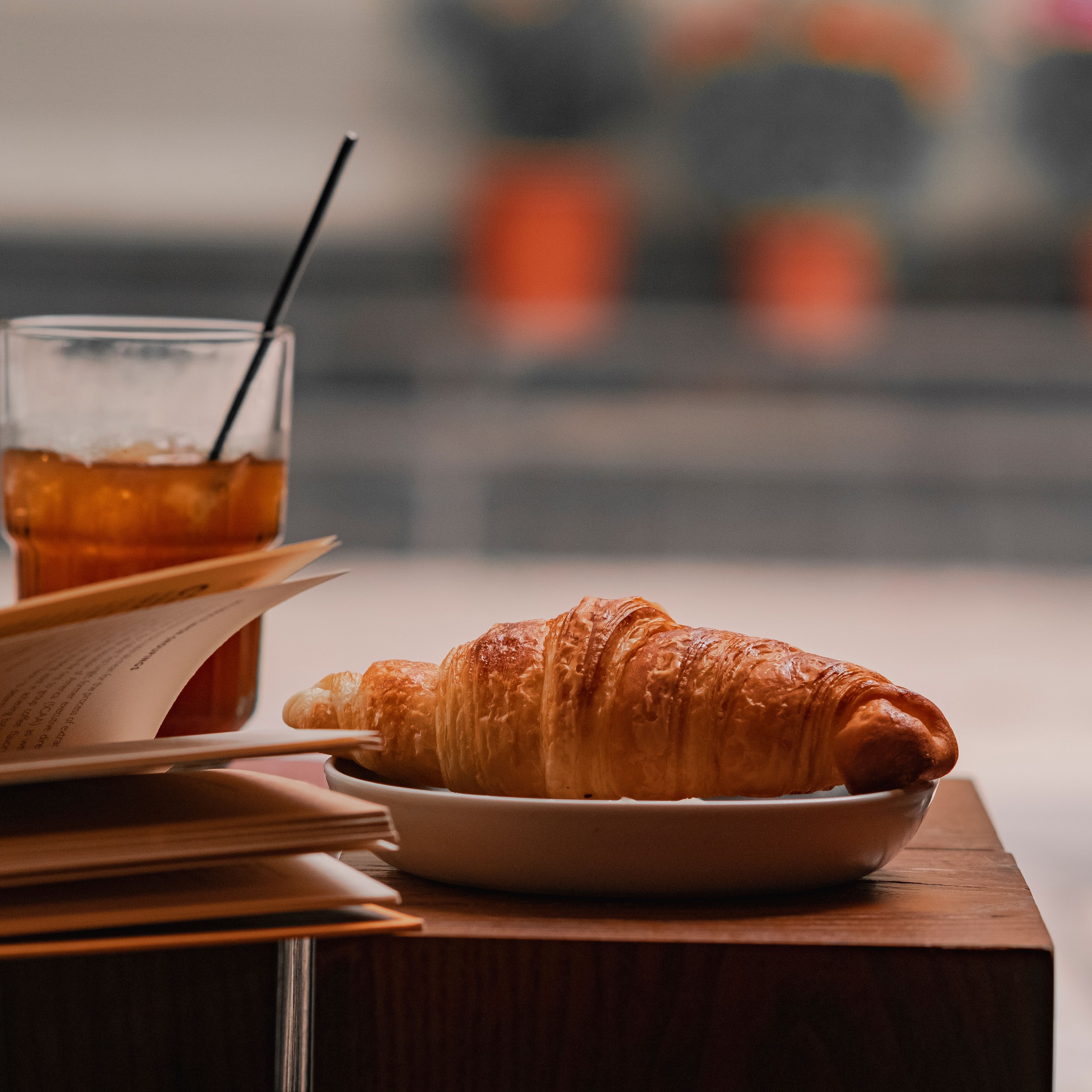 Close-up of a Croissant near a Glass of Juice · Free Stock Photo