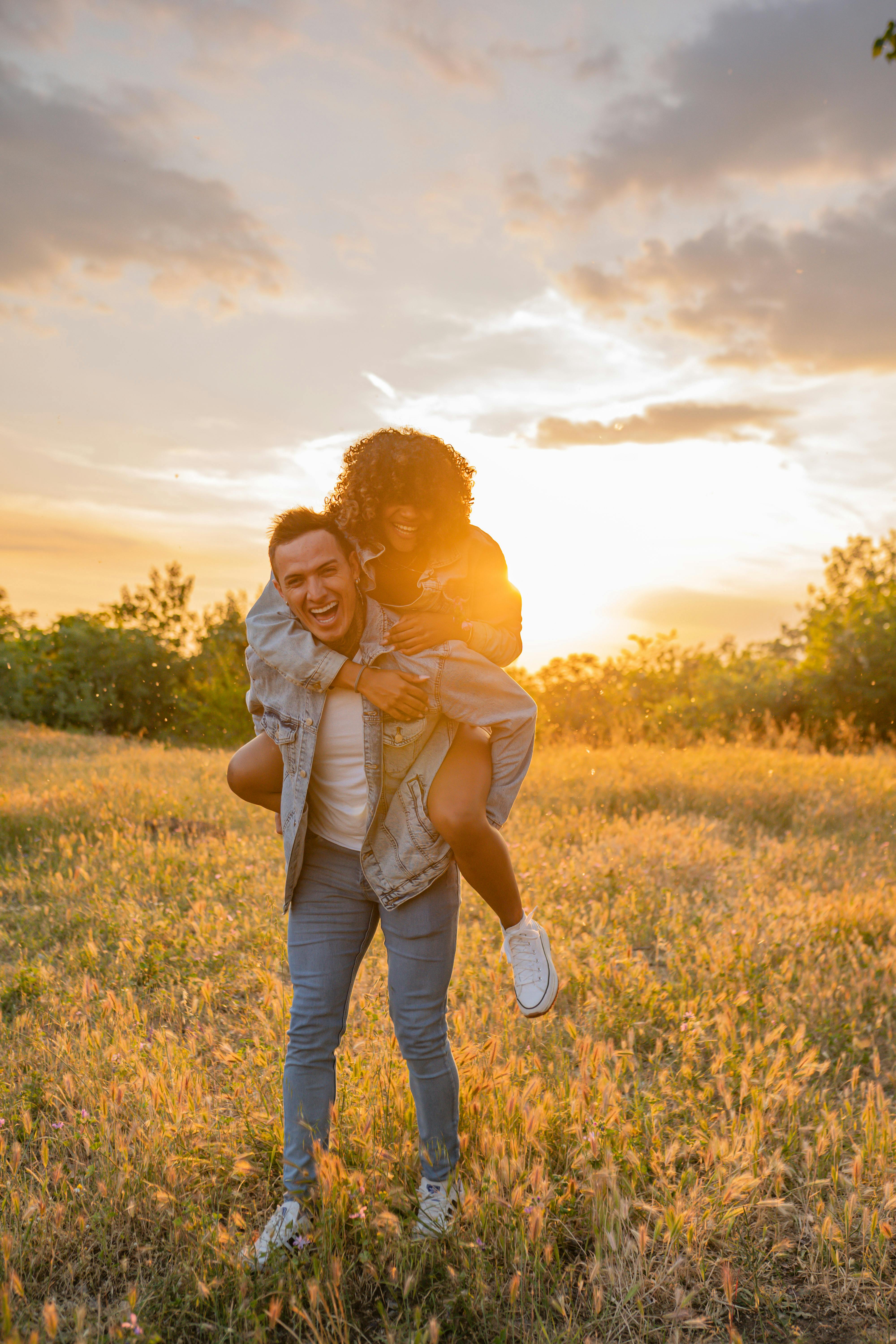 A Man Carrying a Woman on his Back · Free Stock Photo