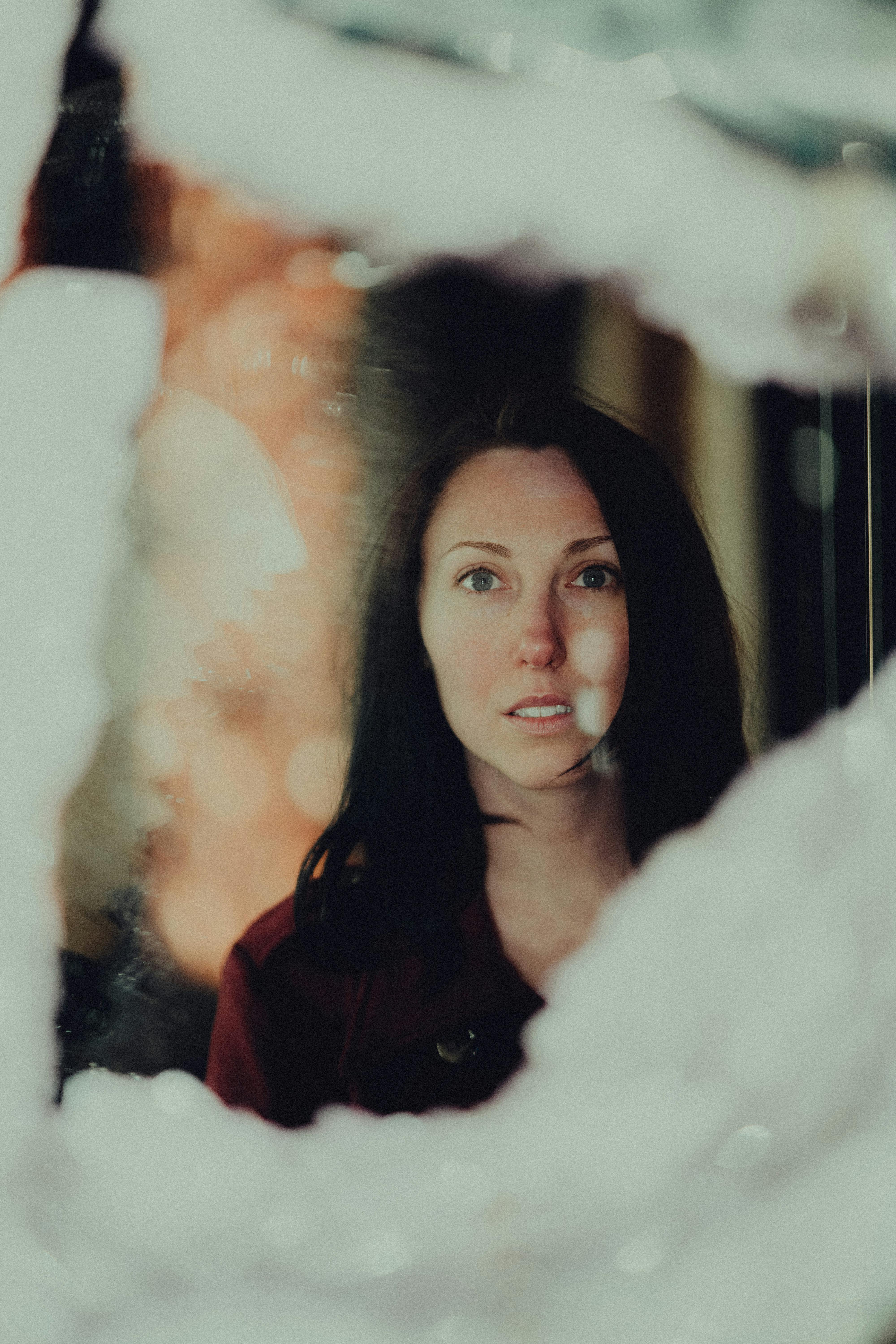 Portrait of a Woman Behind a Window · Free Stock Photo