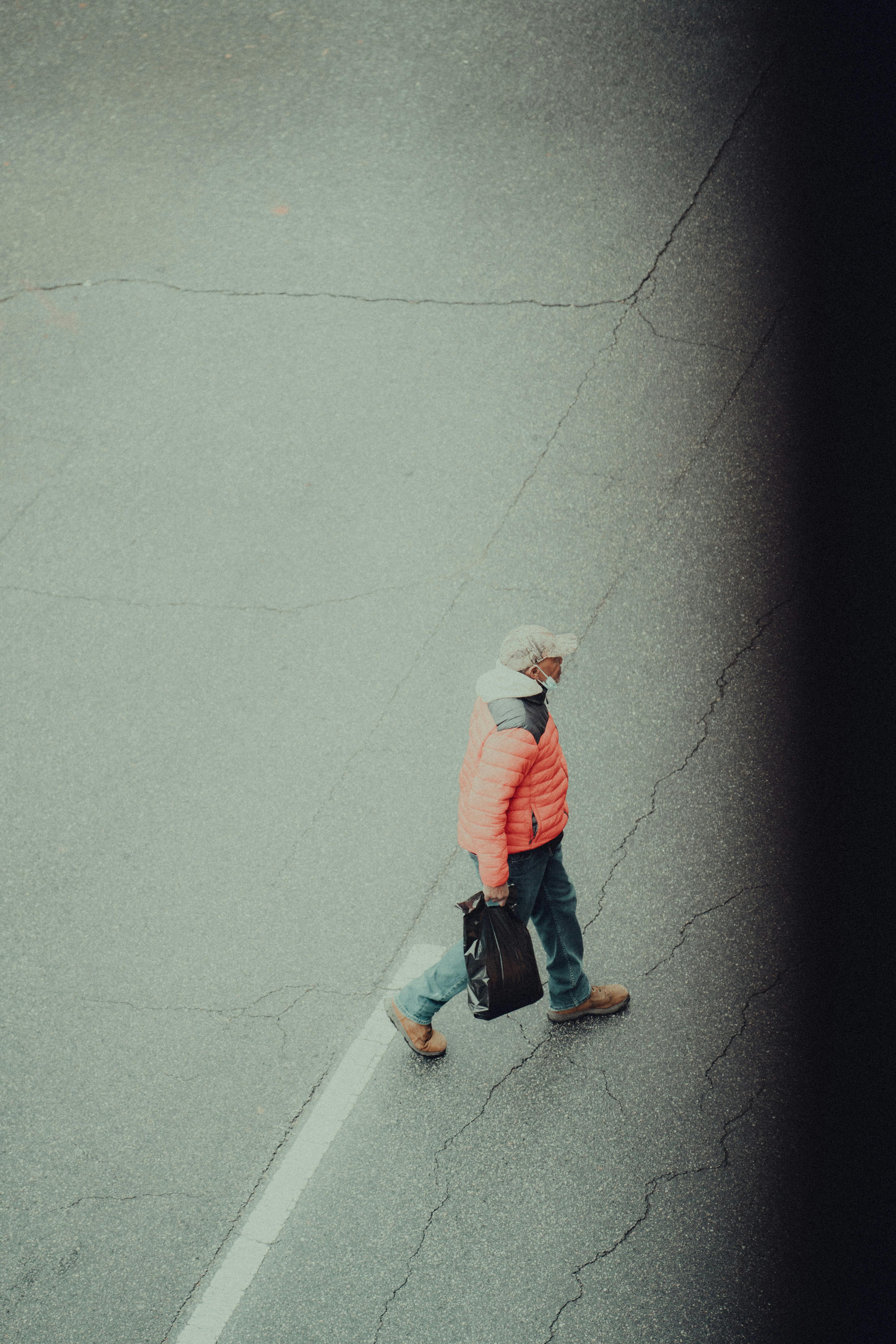 Top View of a Man Walking on the Sidewalk · Free Stock Photo