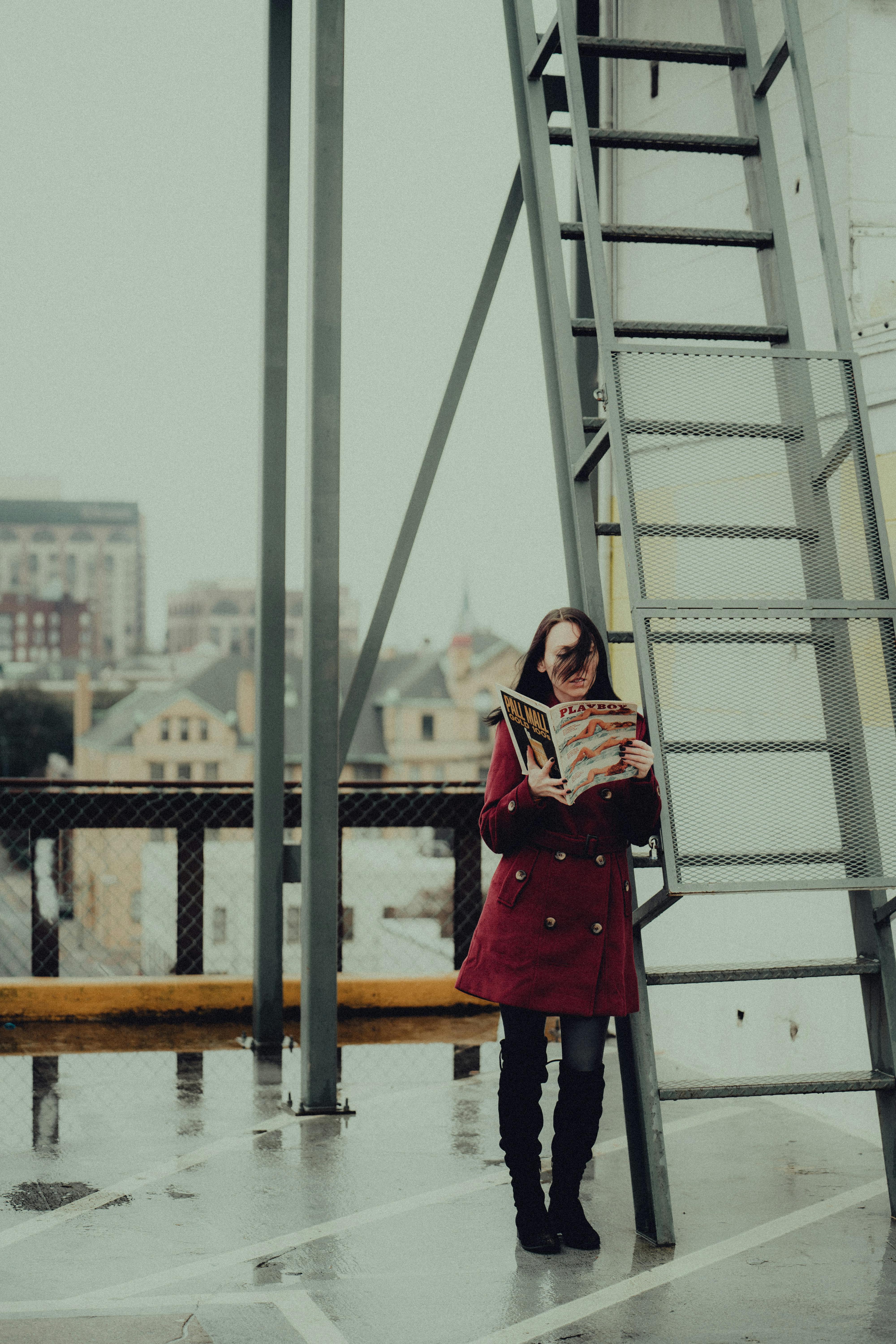 Girl in Fashionable Red Coat Reading Magazine · Free Stock Photo