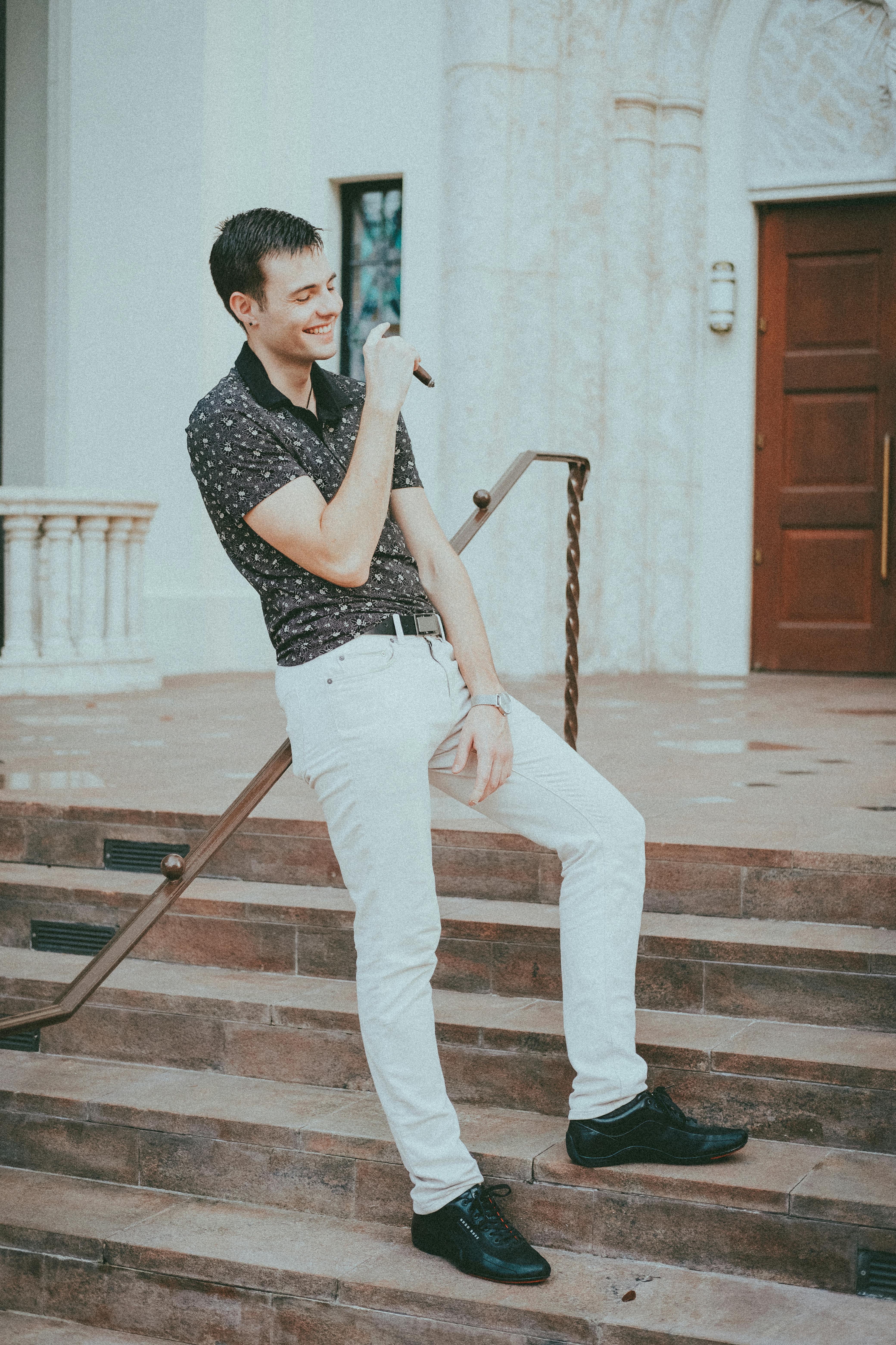 Man Standing on Stairs Smiling · Free Stock Photo