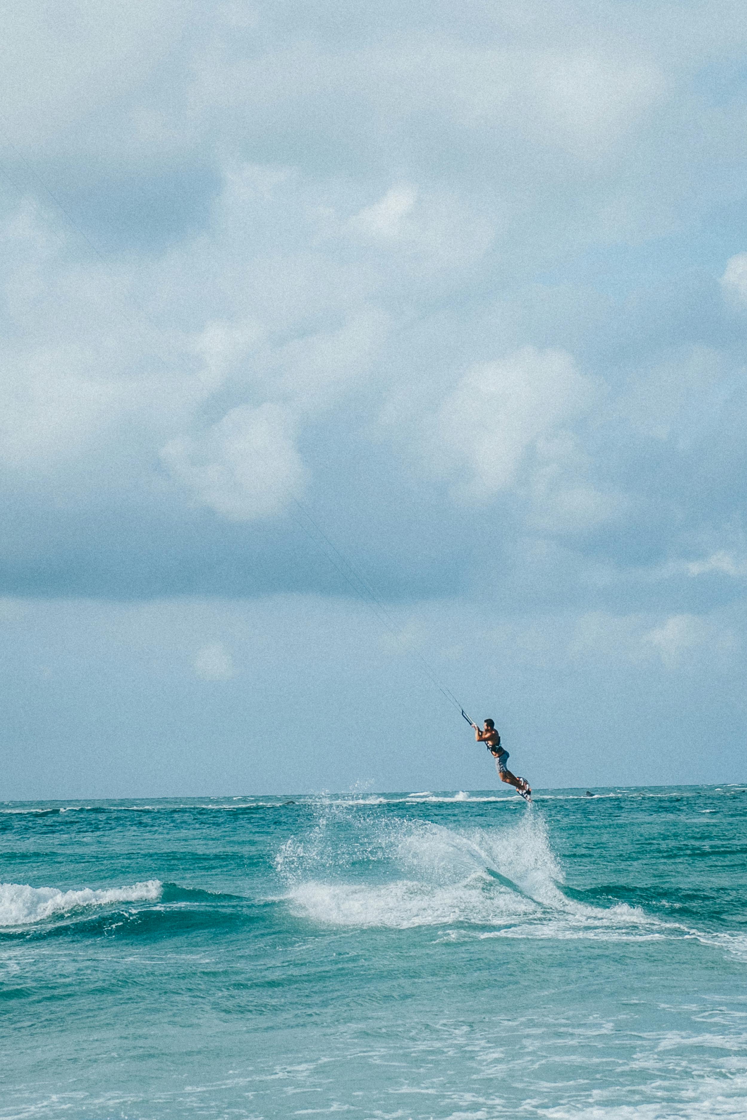 Person Surfing on Blue Ocean Water · Free Stock Photo
