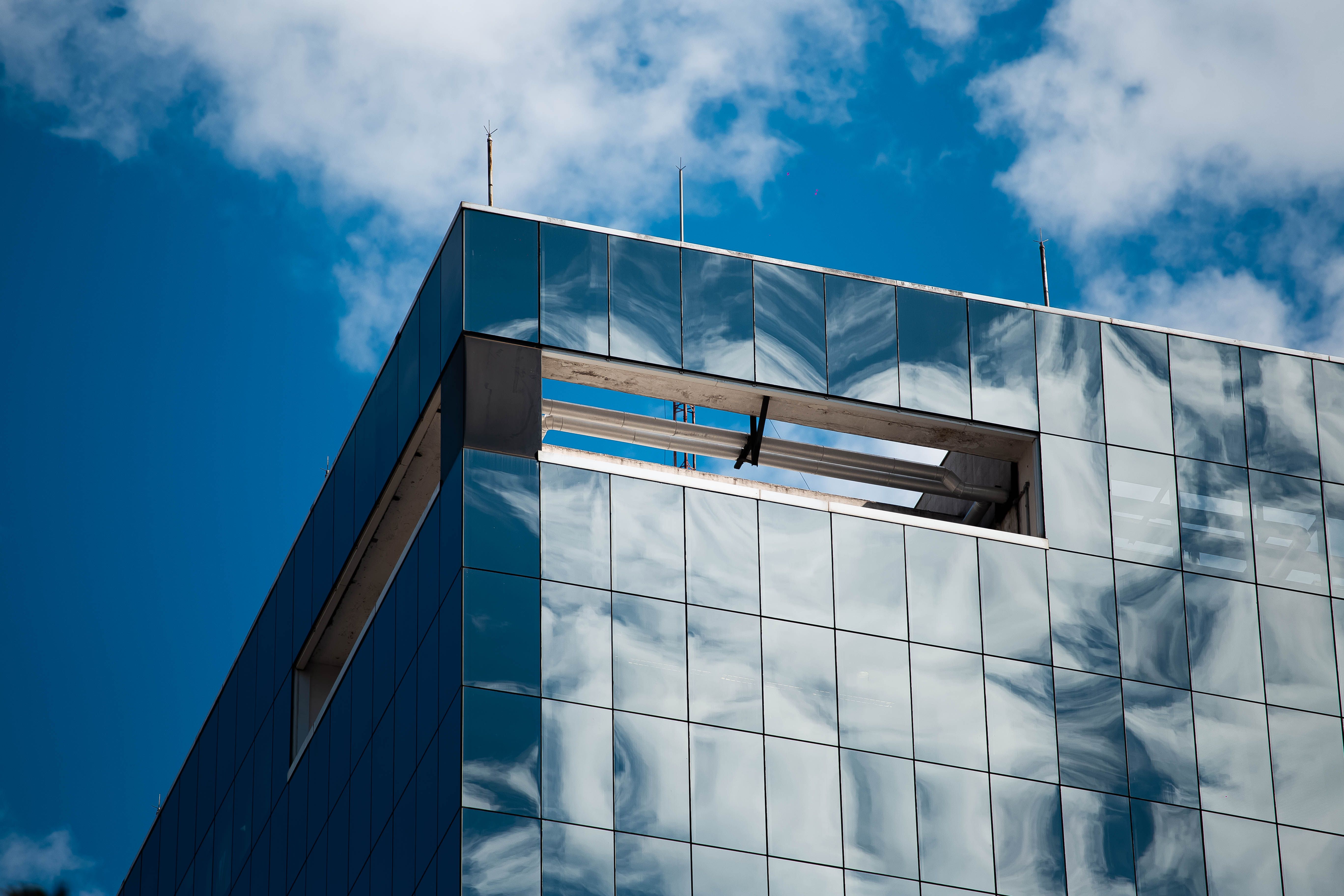 Clouds Reflecting in Glass Wall of Skysc · Free Stock Photo