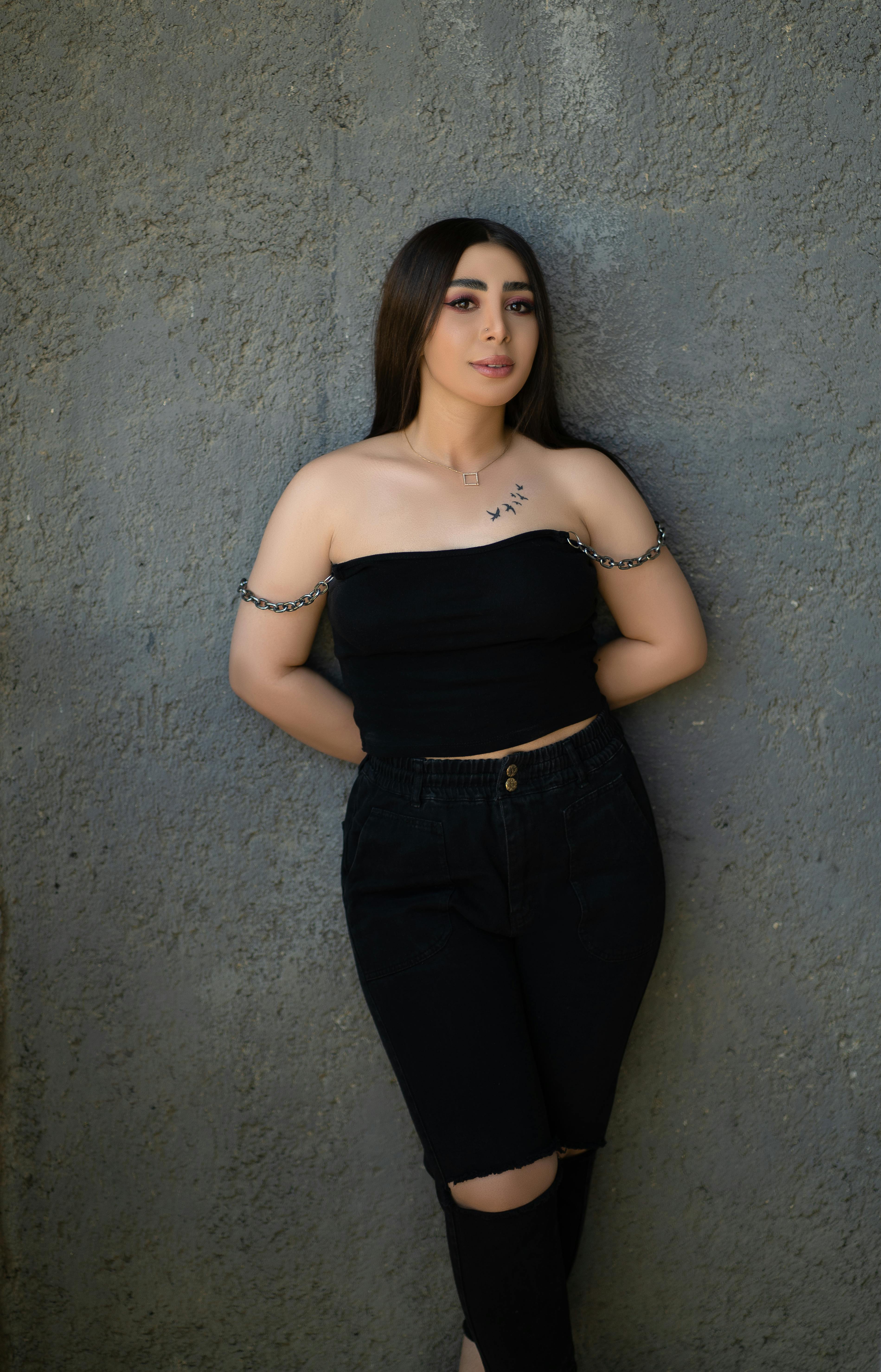 Woman in Black Tank Top and Gray Pants Hugging Brown Textile · Free ...