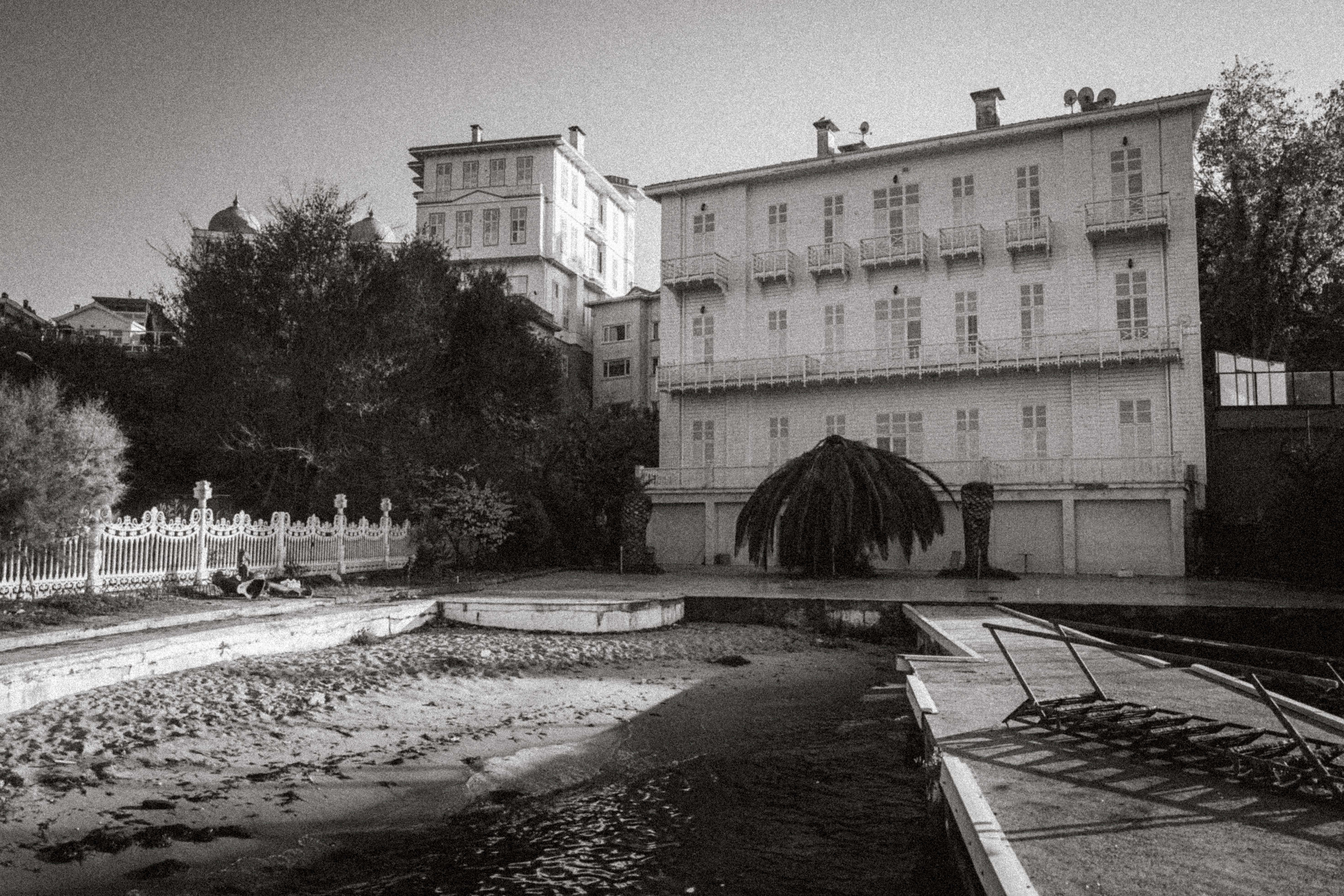 Black and White Photography of a City Building and an Abandoned Pool ...