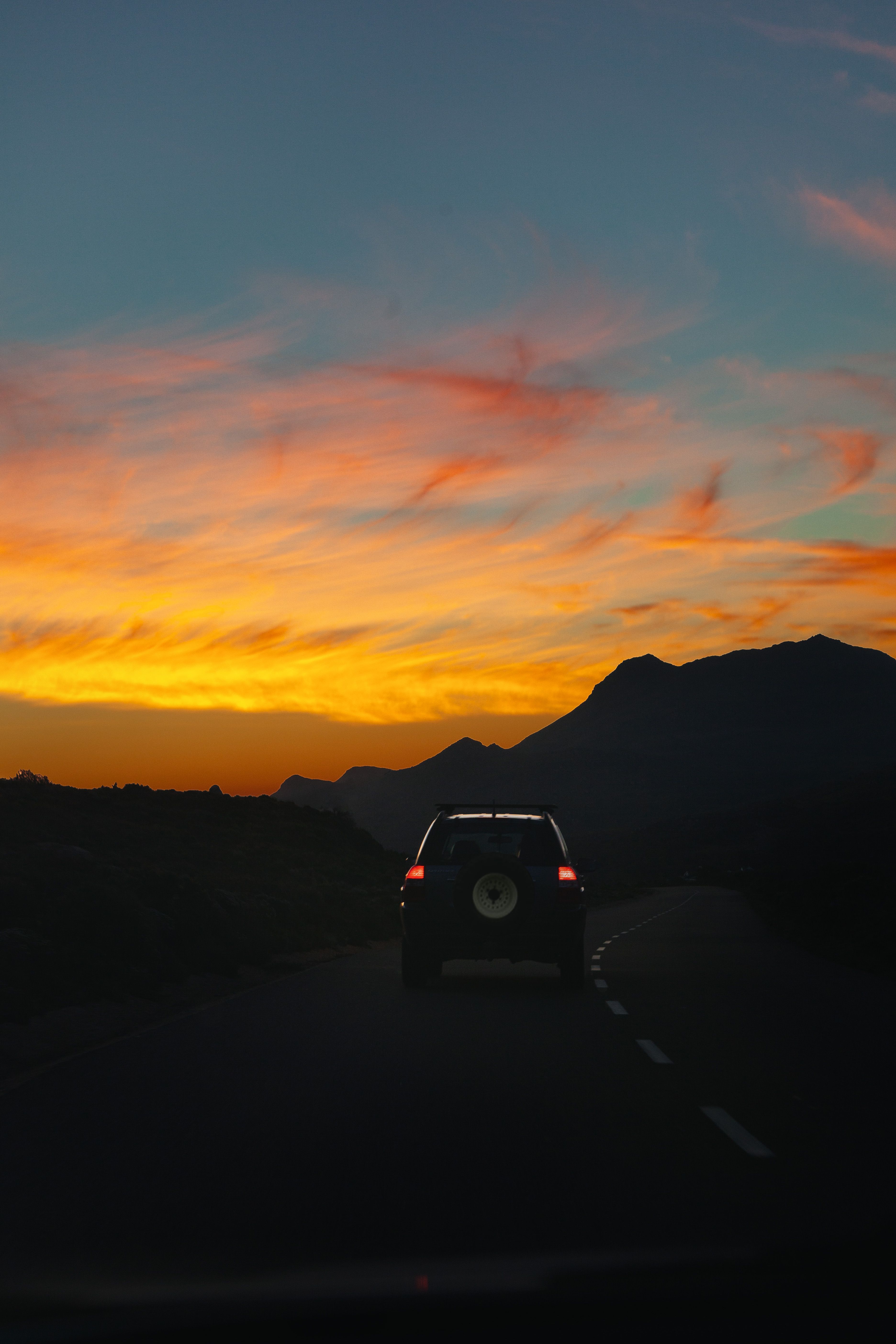 Car Driving on Road on Sunset · Free Stock Photo
