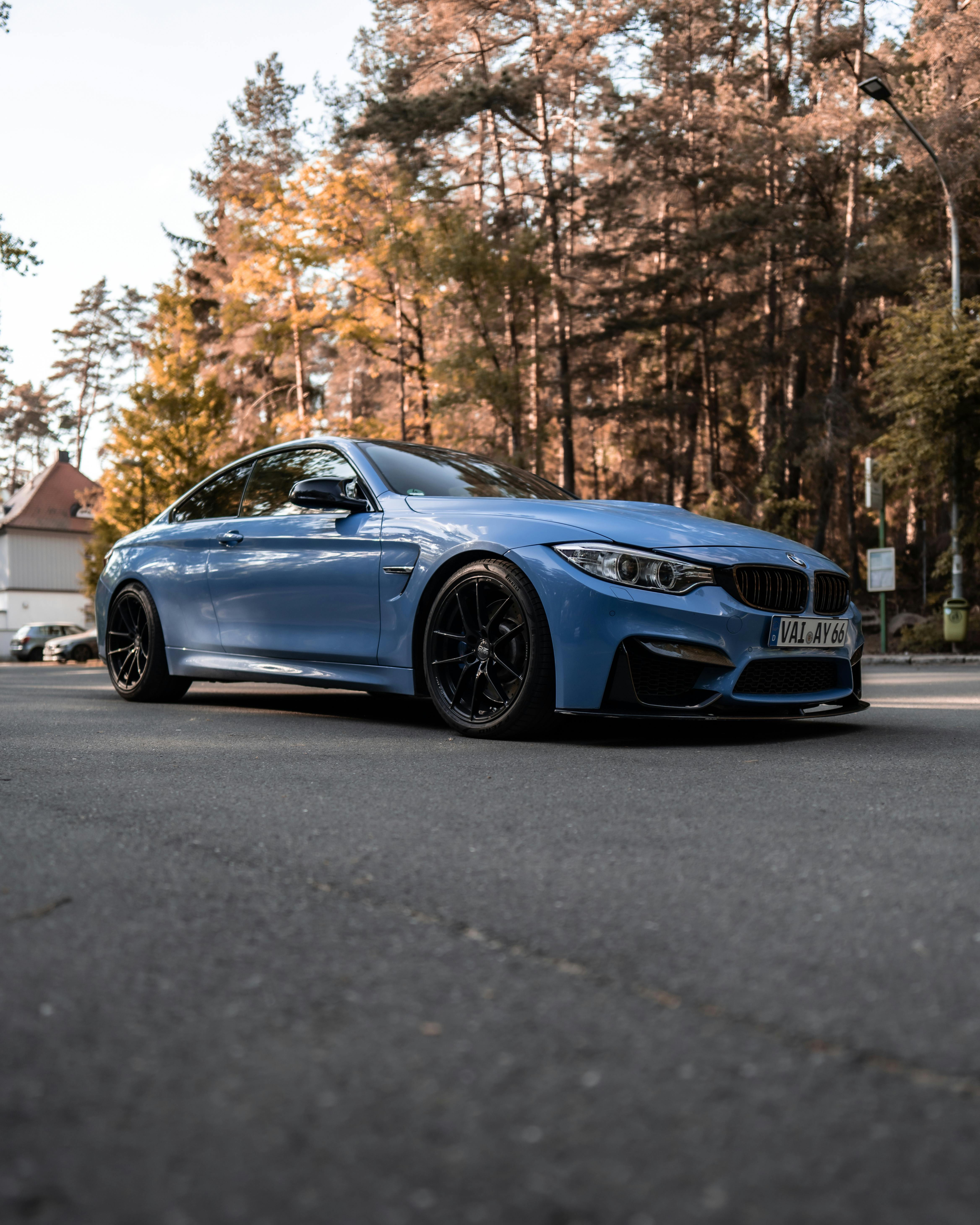 Low-Angle Shot of a Blue Car · Free Stock Photo