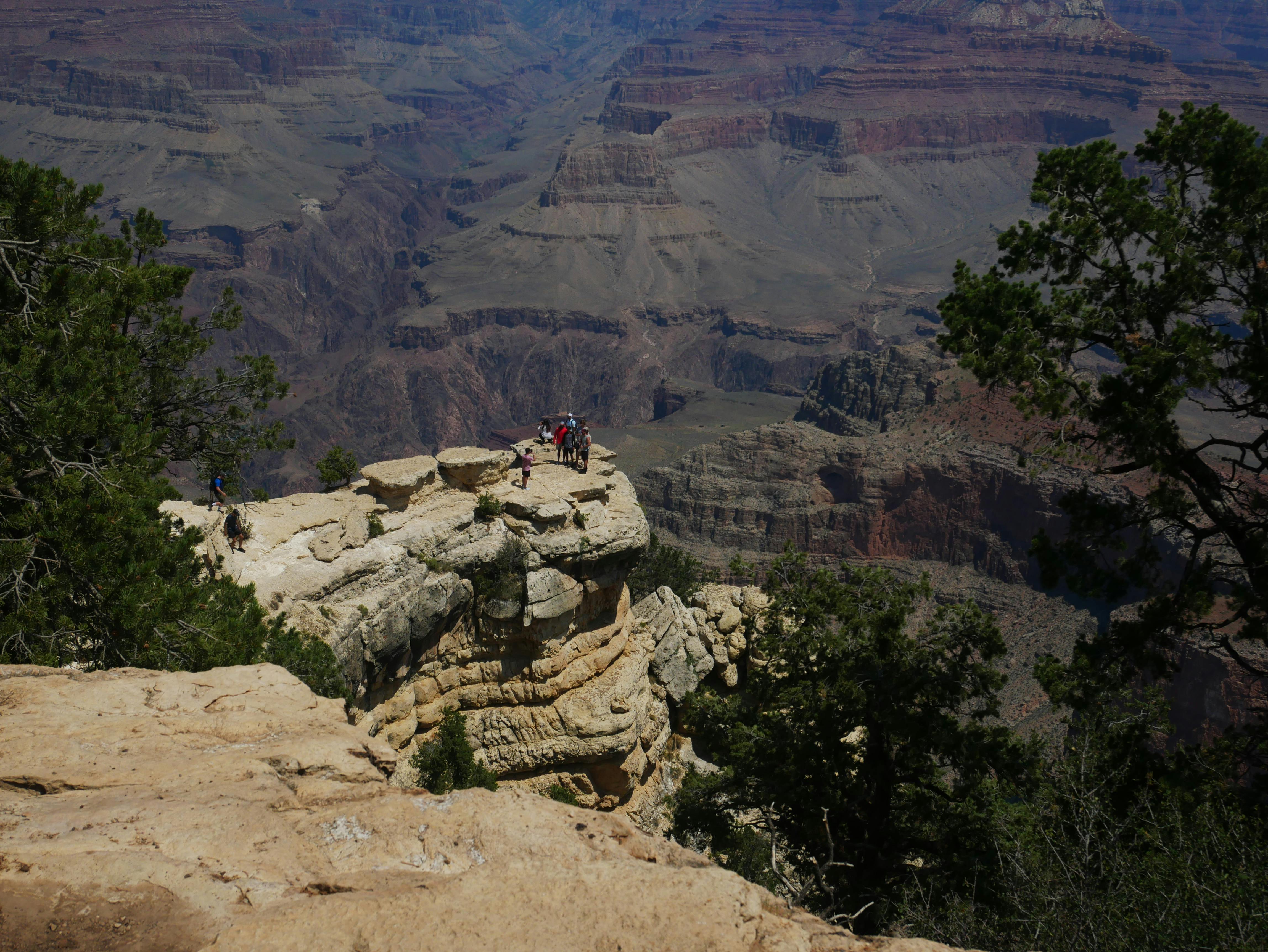A Group of People Standing on Top of the Grand Canyon in Arizona ...