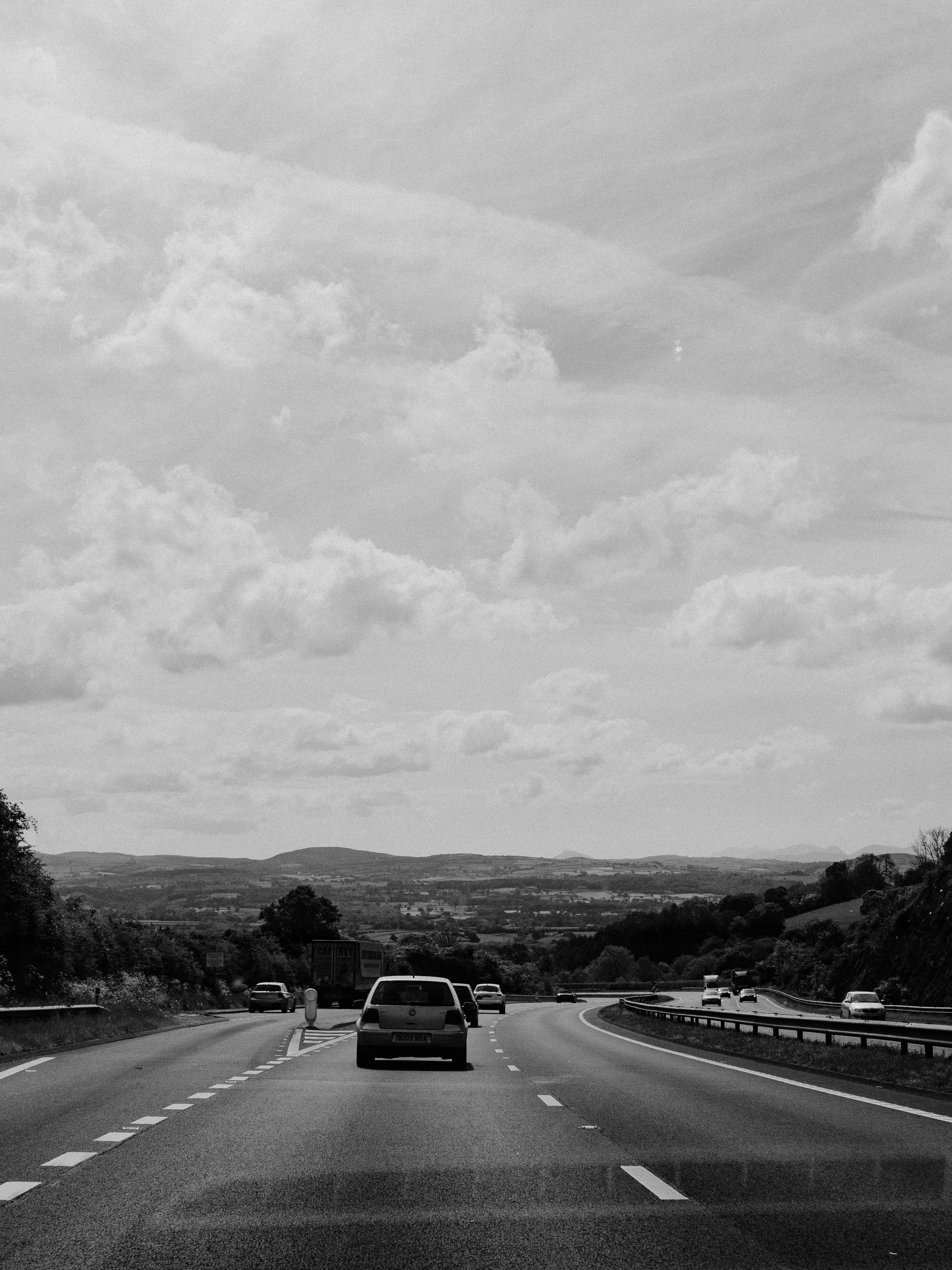 Grayscale Photo of Cars on a Road · Free Stock Photo
