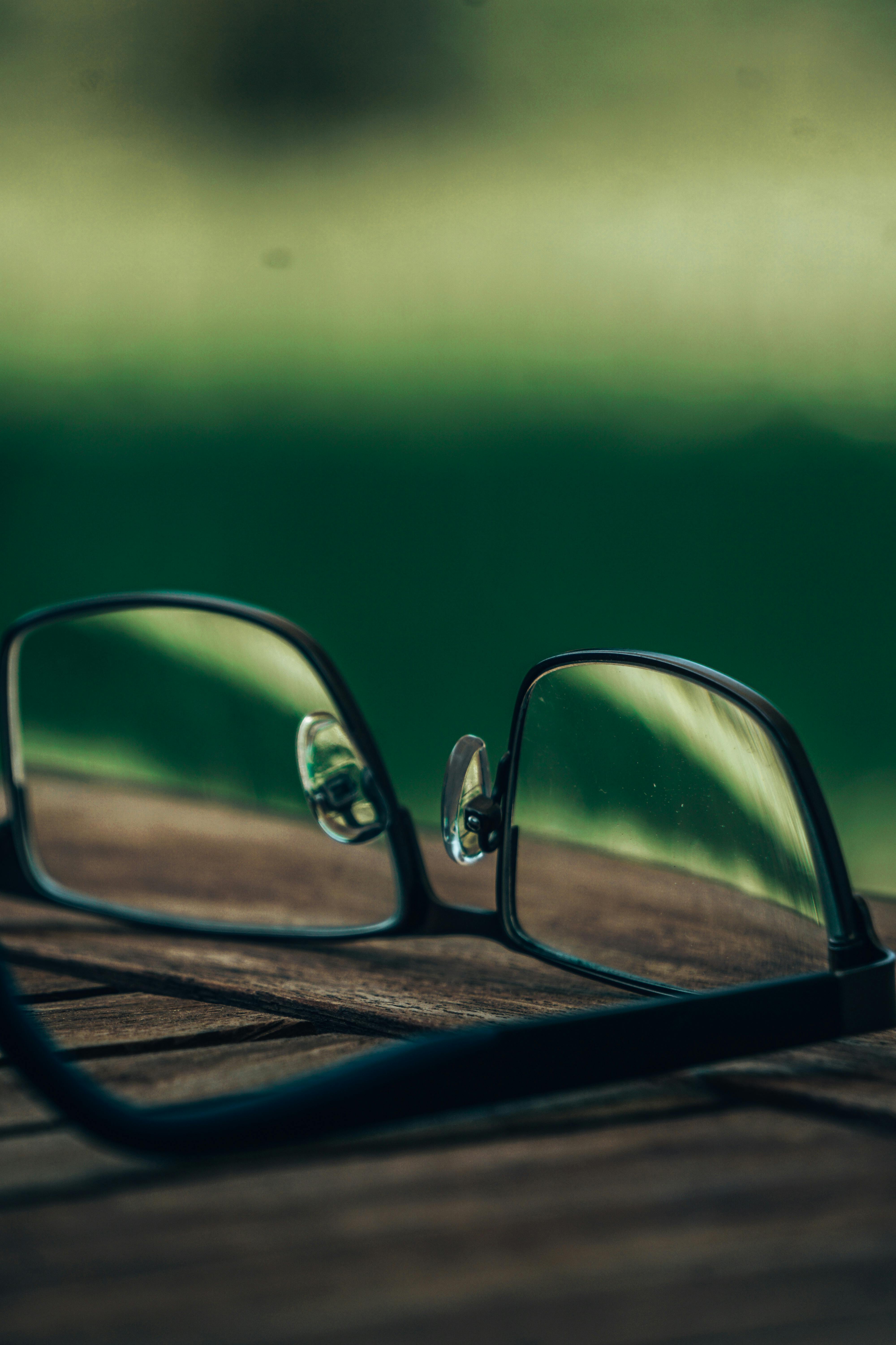 A Close-Up Shot of a Pair of Eyeglasses beside an Hourglass · Free ...
