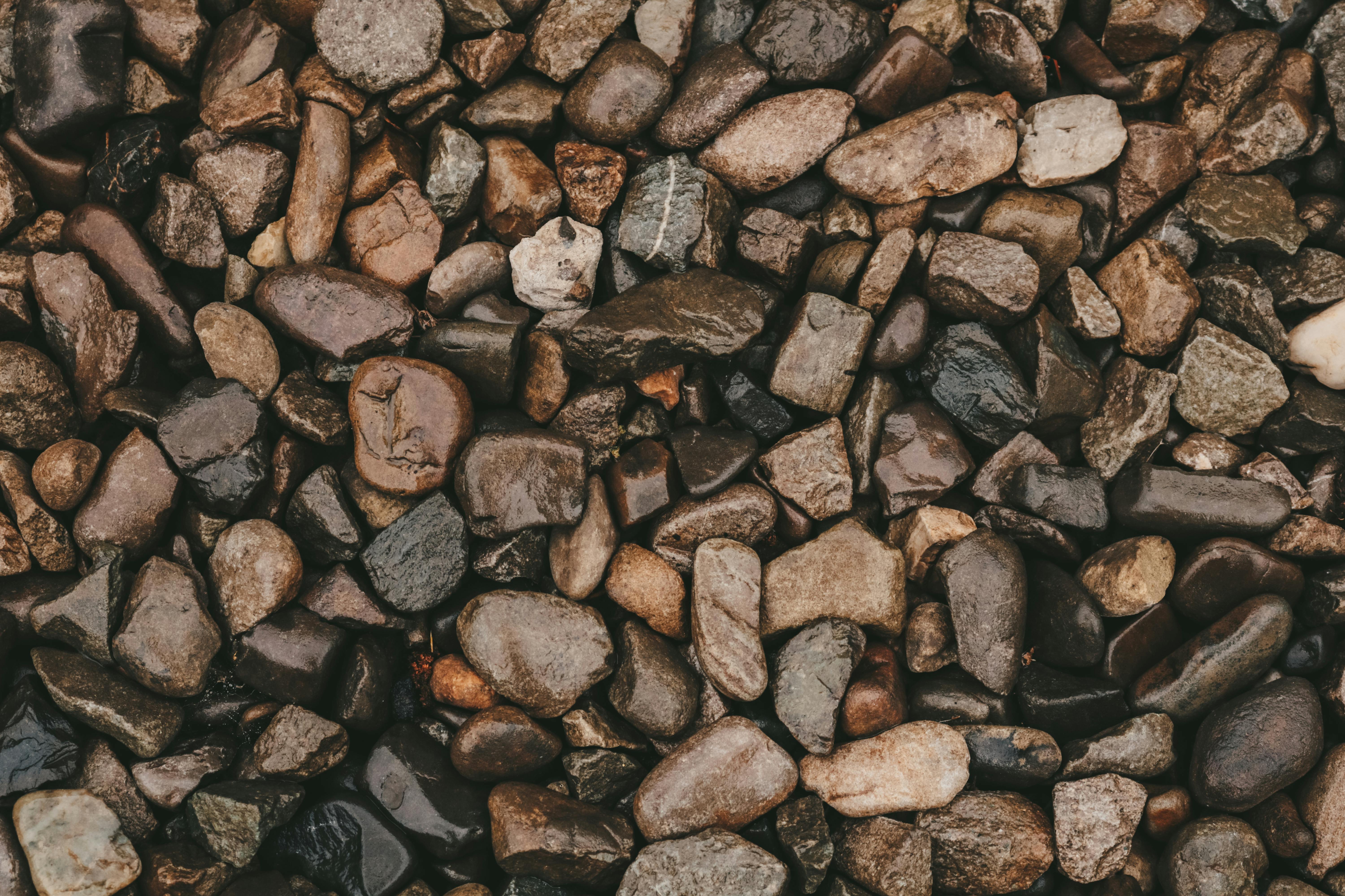 Pile of Beige Stone on Brown Wood Surface · Free Stock Photo