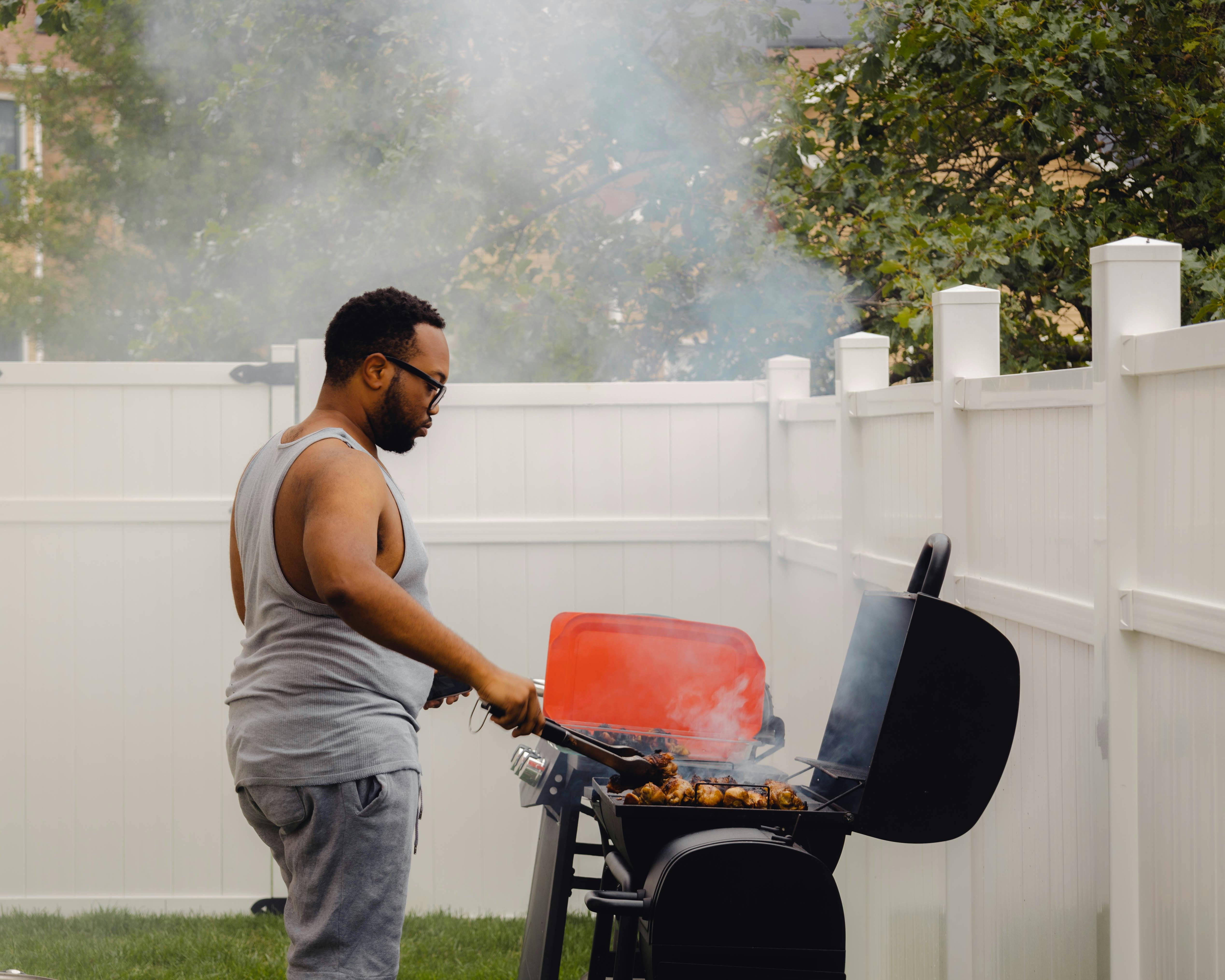 Man in Gray Tank Top Grilling · Free Stock Photo