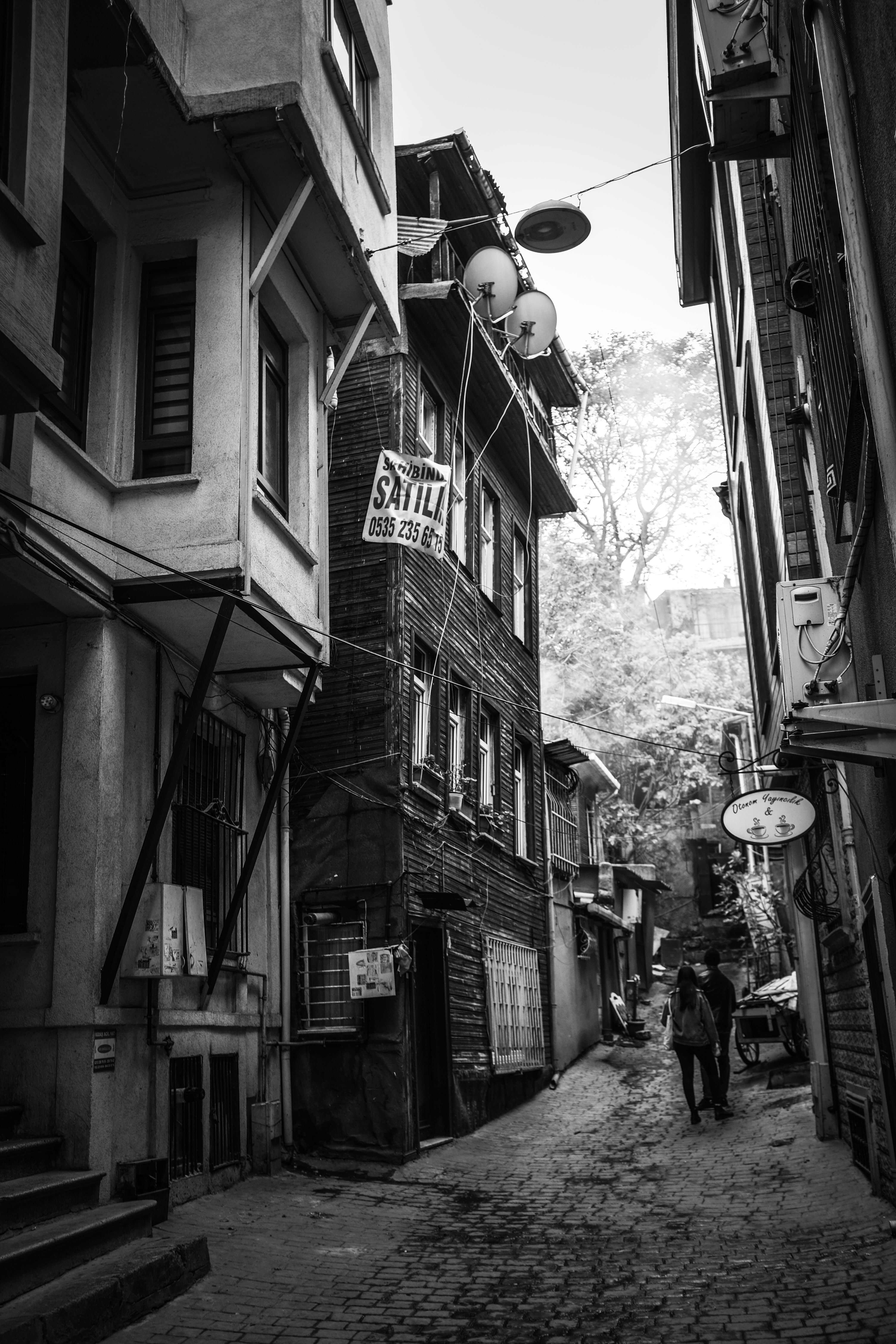 A Grayscale of a Street with a Cobblestone Pavement · Free Stock Photo