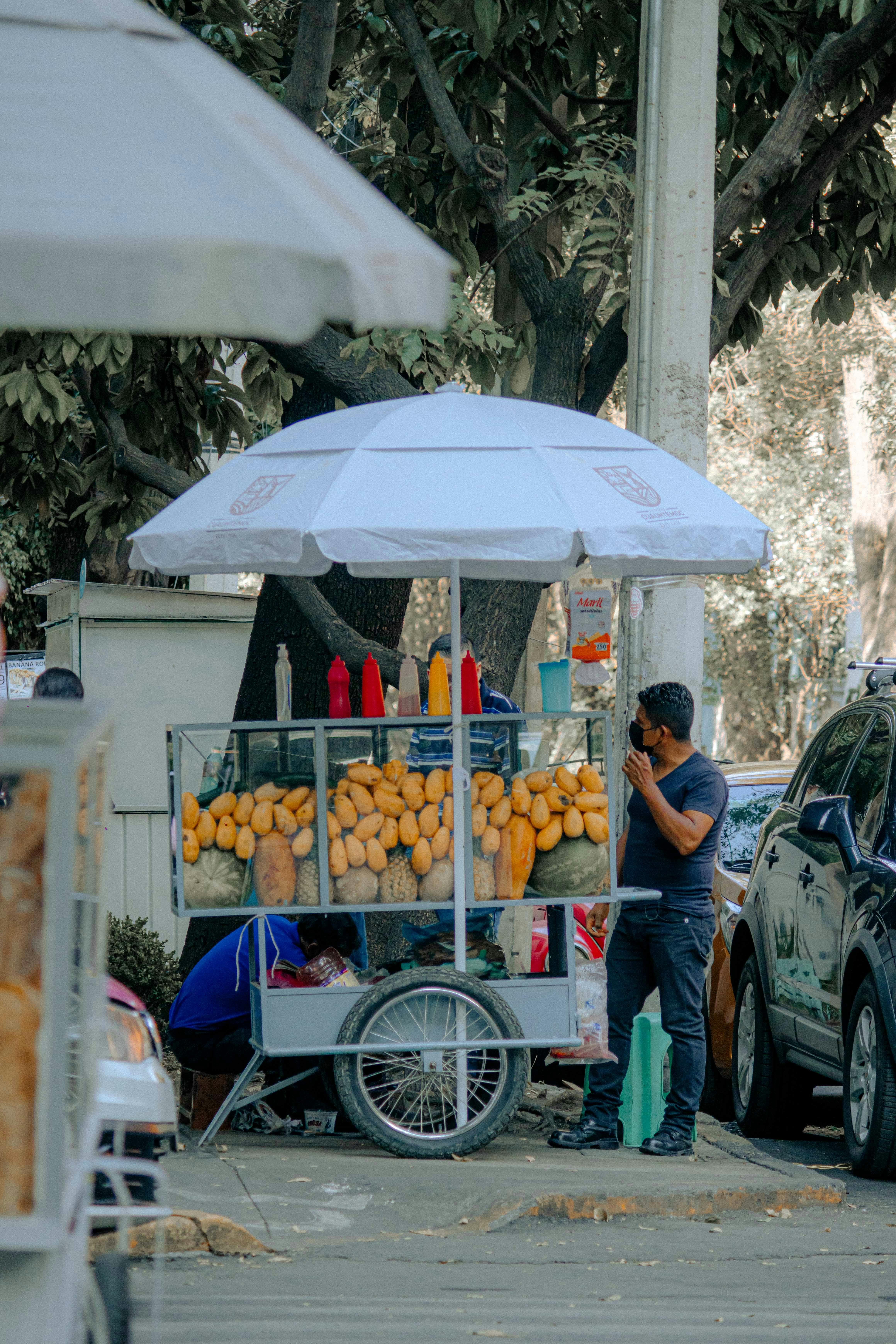 A Street Vendor on a Sidewalk · Free Stock Photo