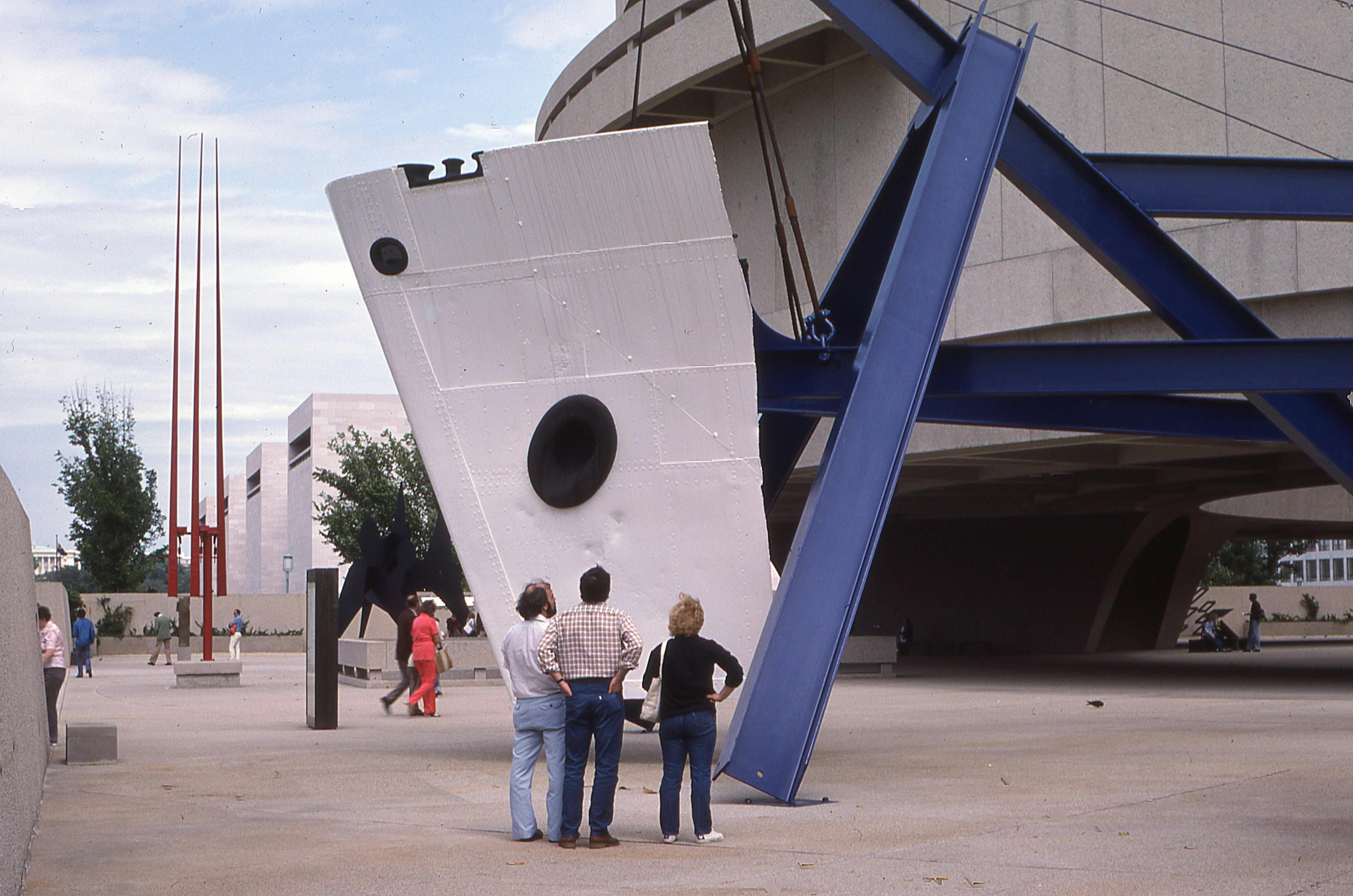 People Standing Beside the Steel Structure Near the Concrete Building ...