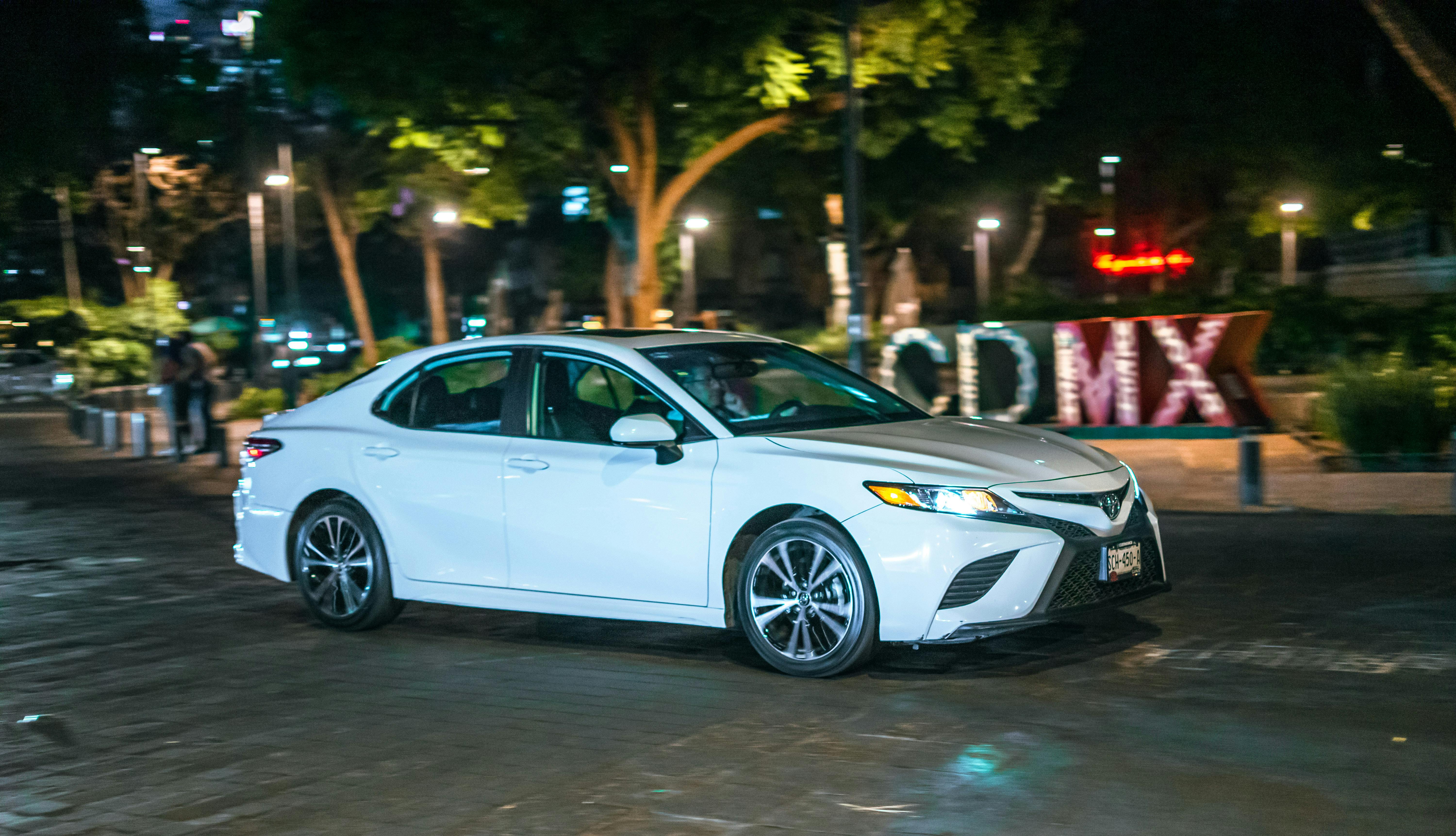 A Beautiful White Car Moving on the Car · Free Stock Photo
