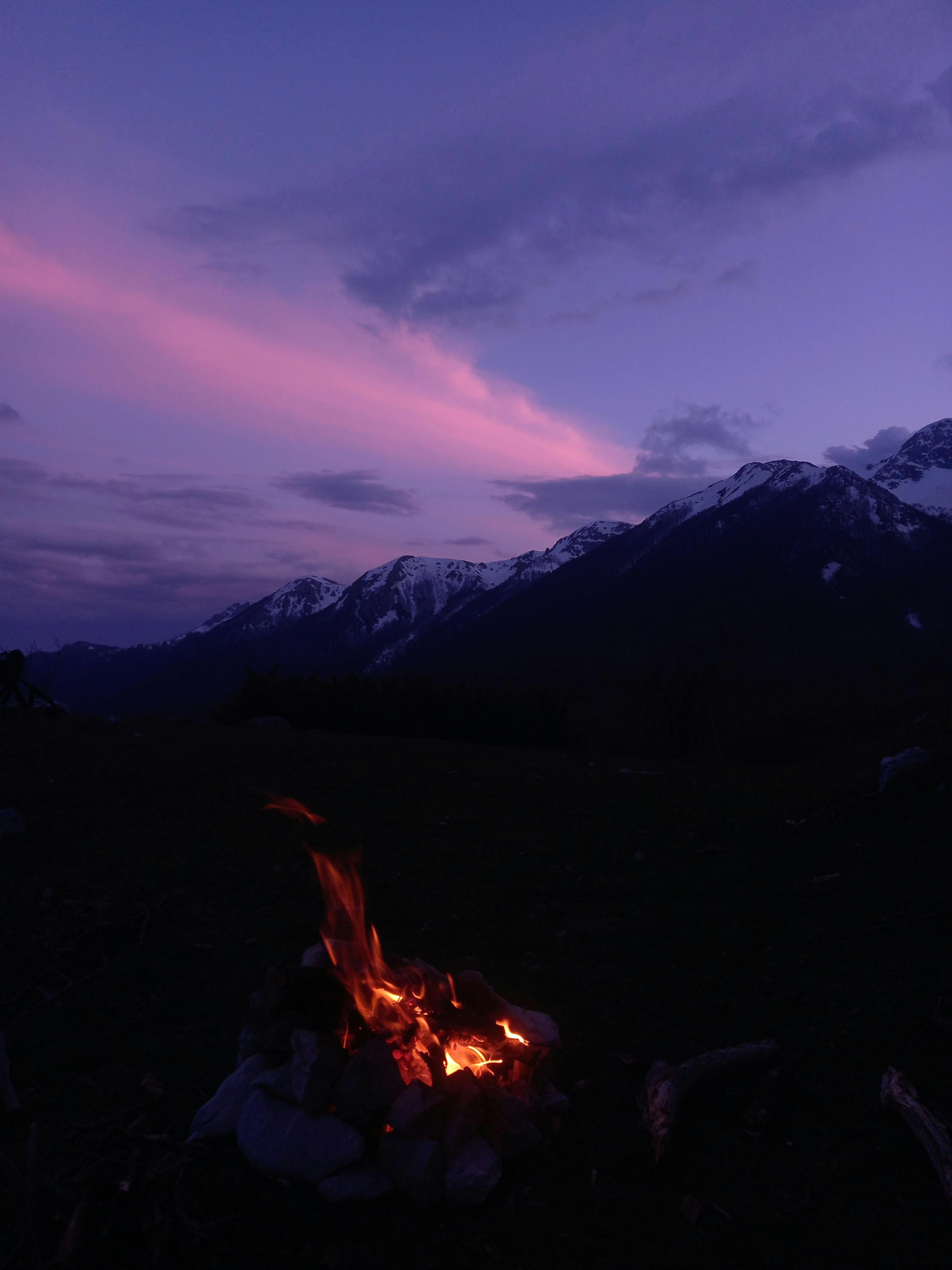 Fire on Ground Near Mountains · Free Stock Photo