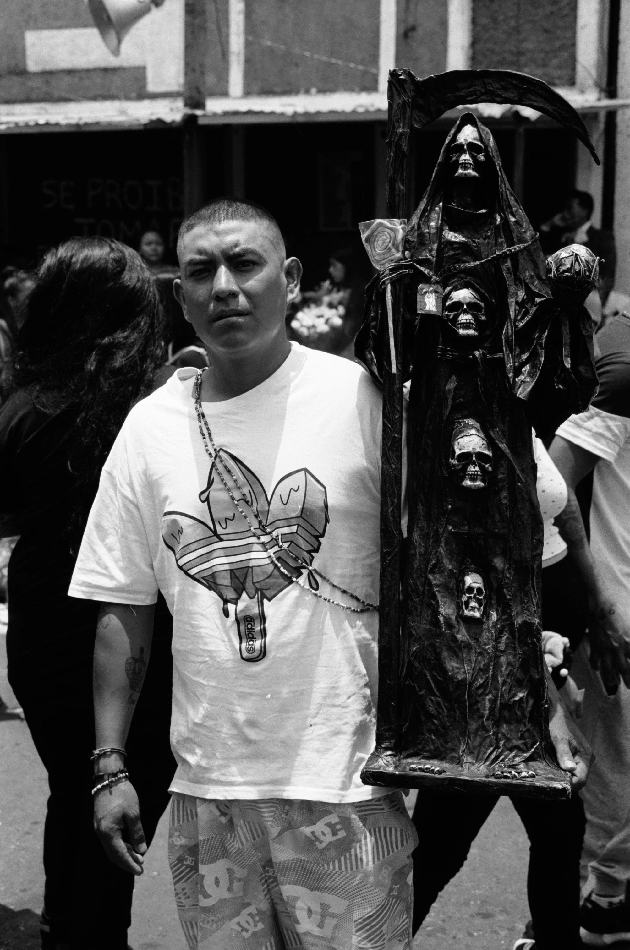 Monochrome Photo of Man holding a Small Reaper Statue · Free Stock Photo