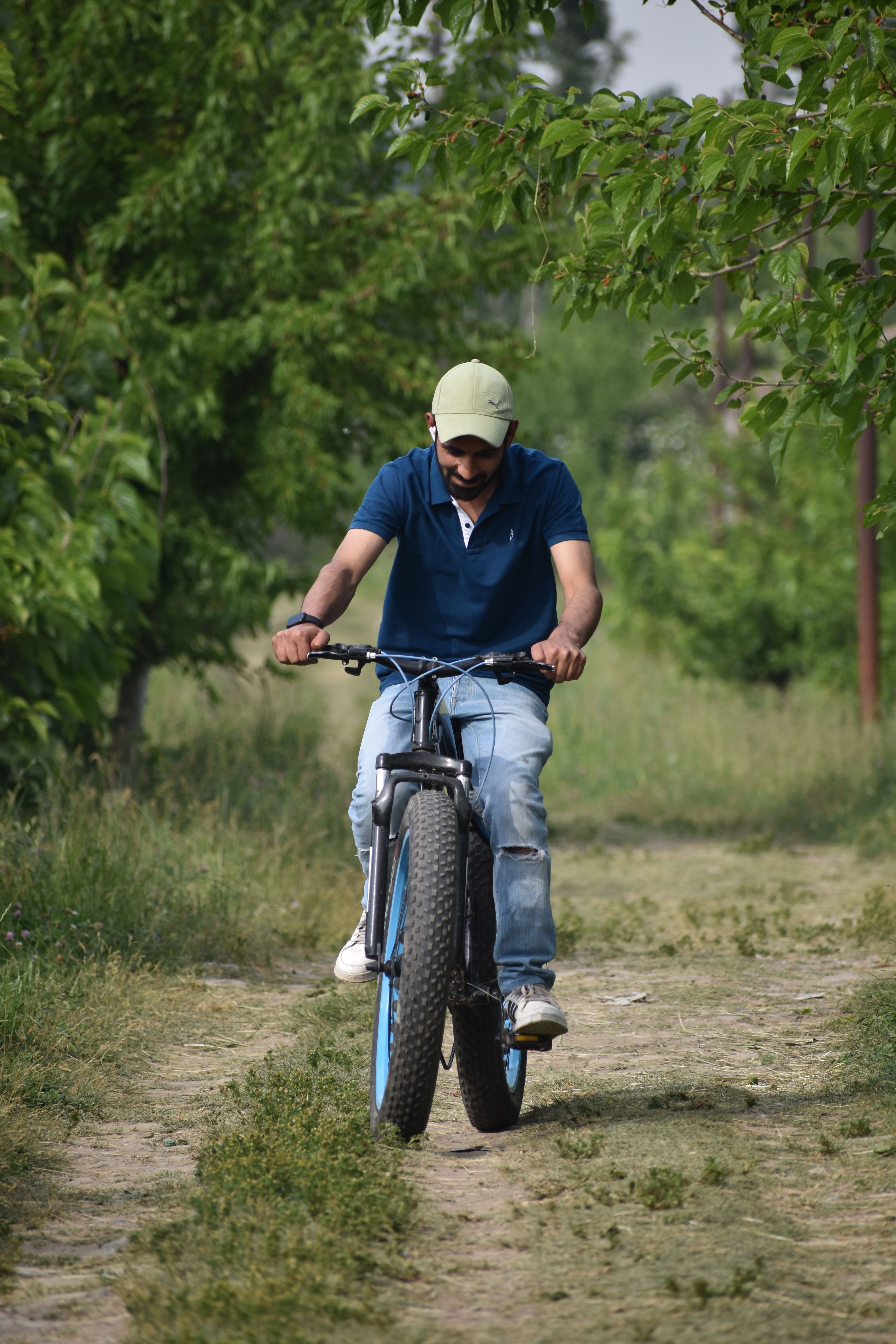 Two Bikers on Bush-lined Path · Free Stock Photo