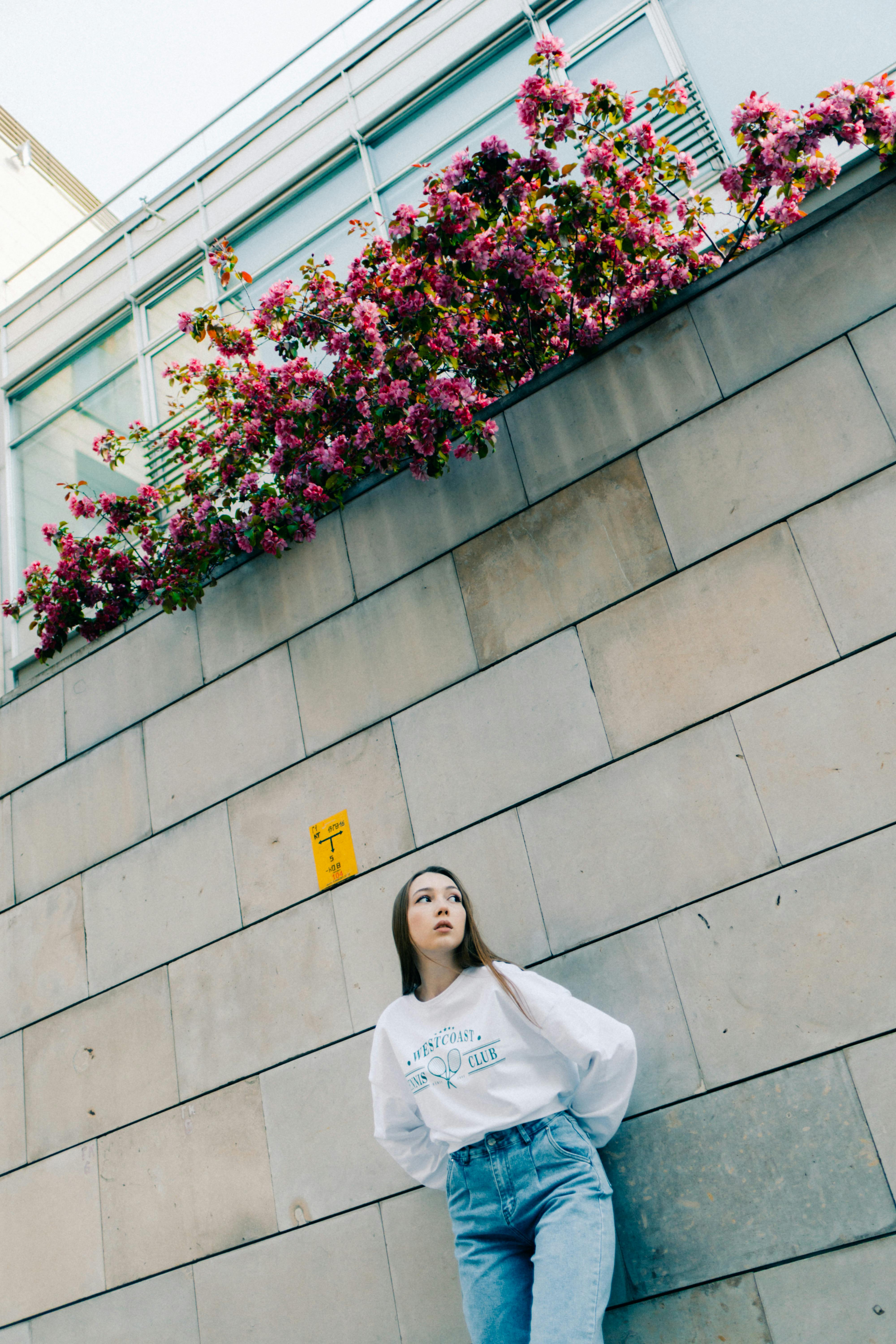 Girl in White Shirt Near a Glass Window · Free Stock Photo