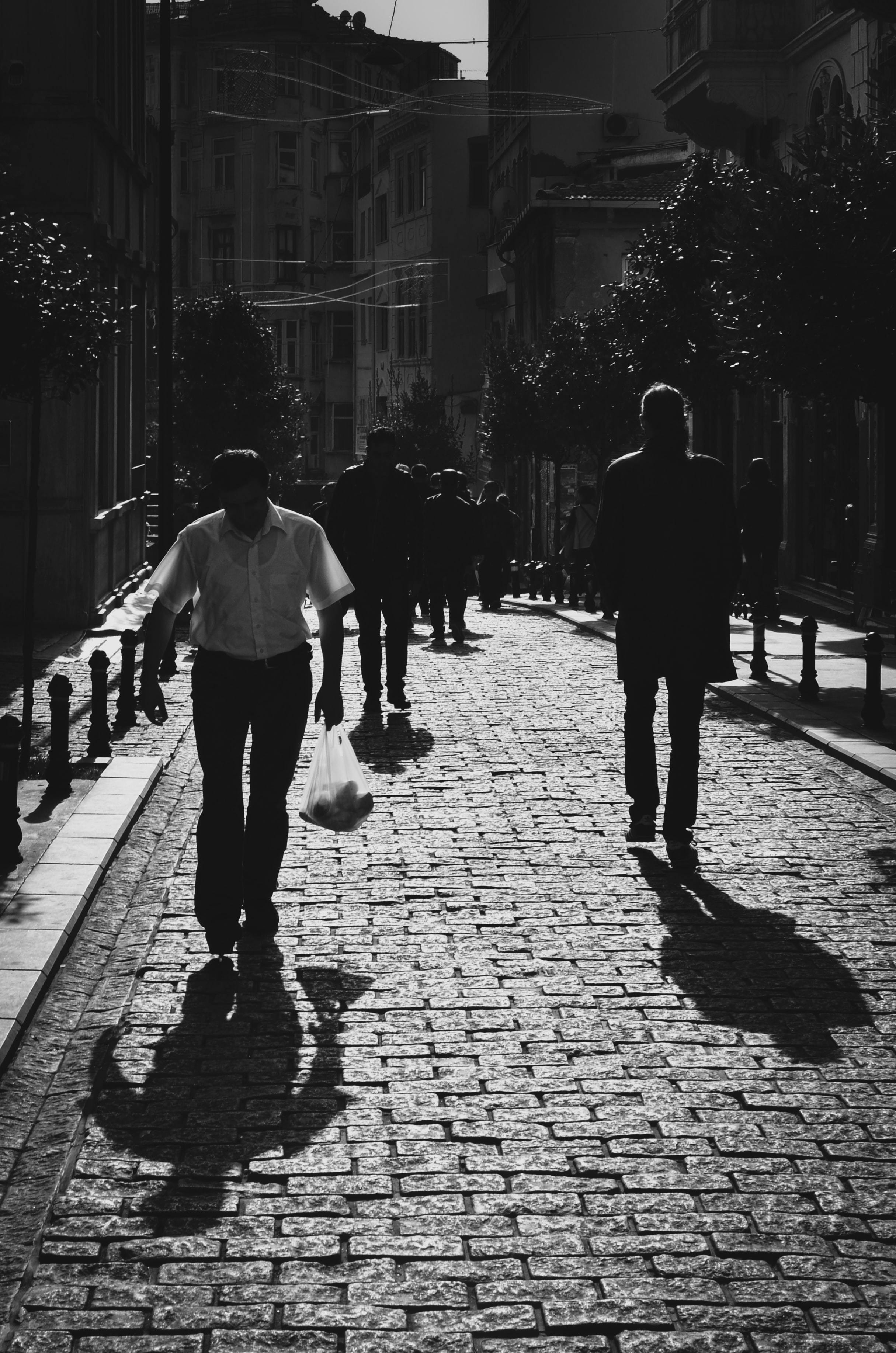 A Lone Figure Standing In The Middle Of Bustling City Street ...