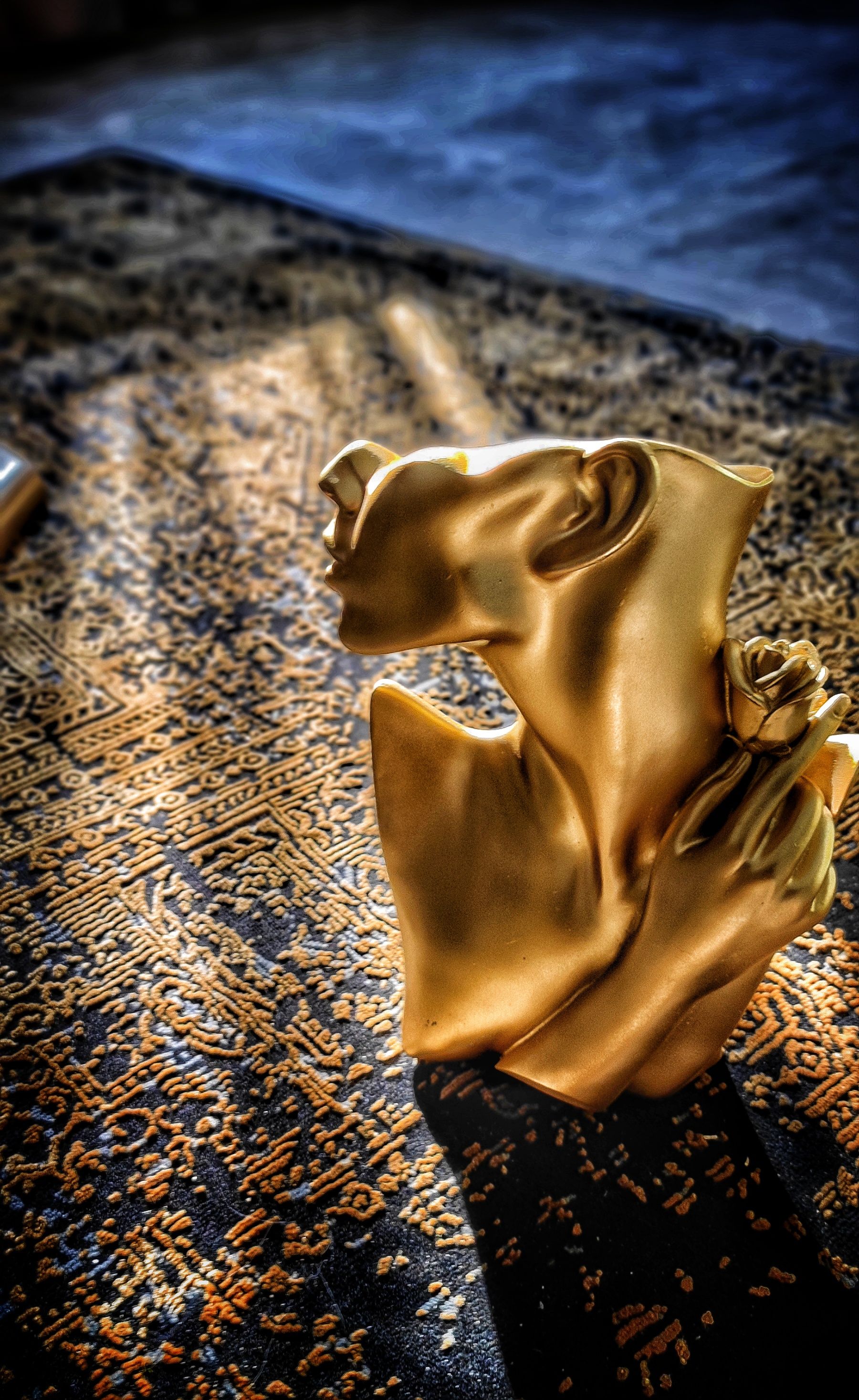 A Gold Statue on Black and Gold Textile · Free Stock Photo