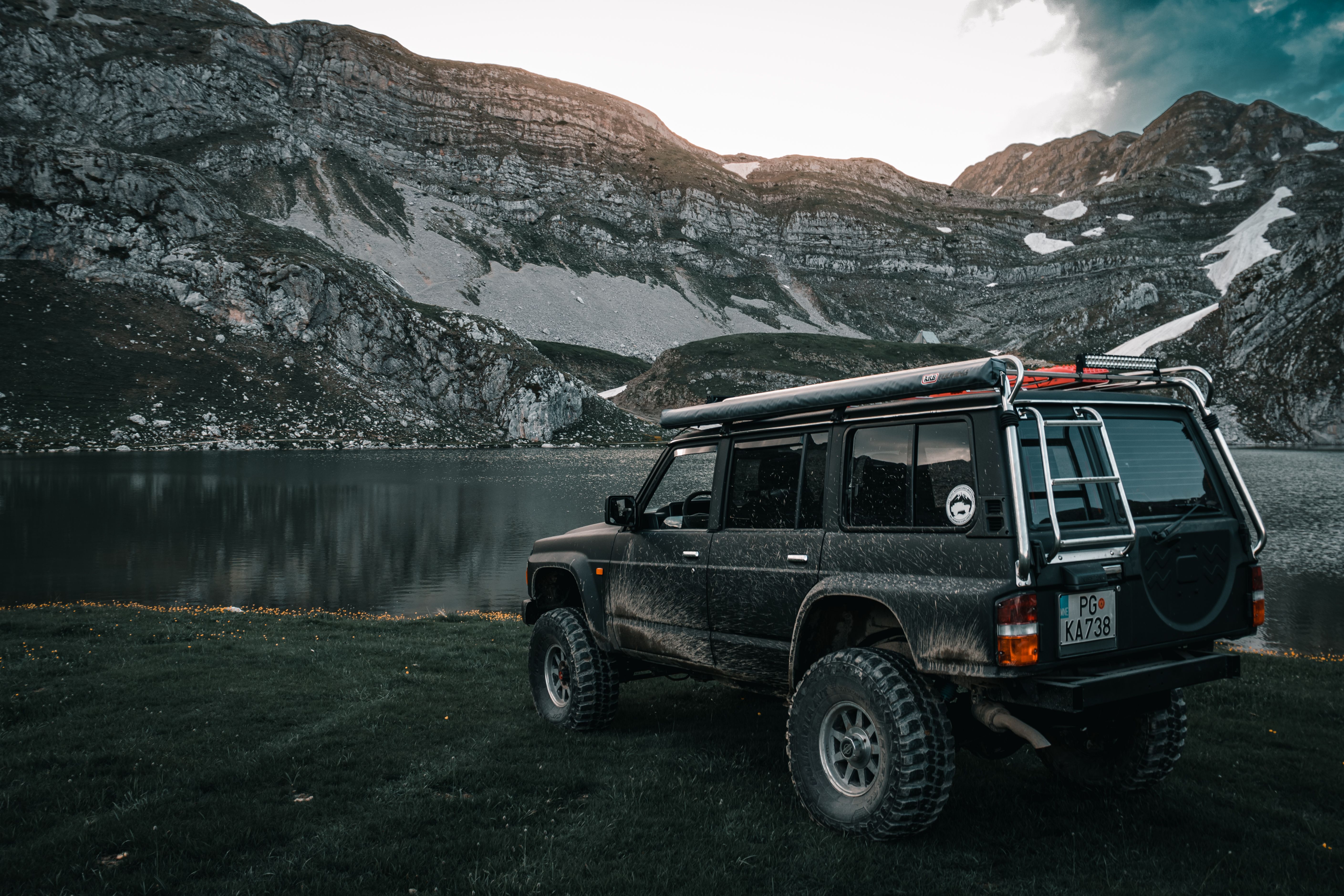 Man Off-road with His Car Stuck in Mud · Free Stock Photo