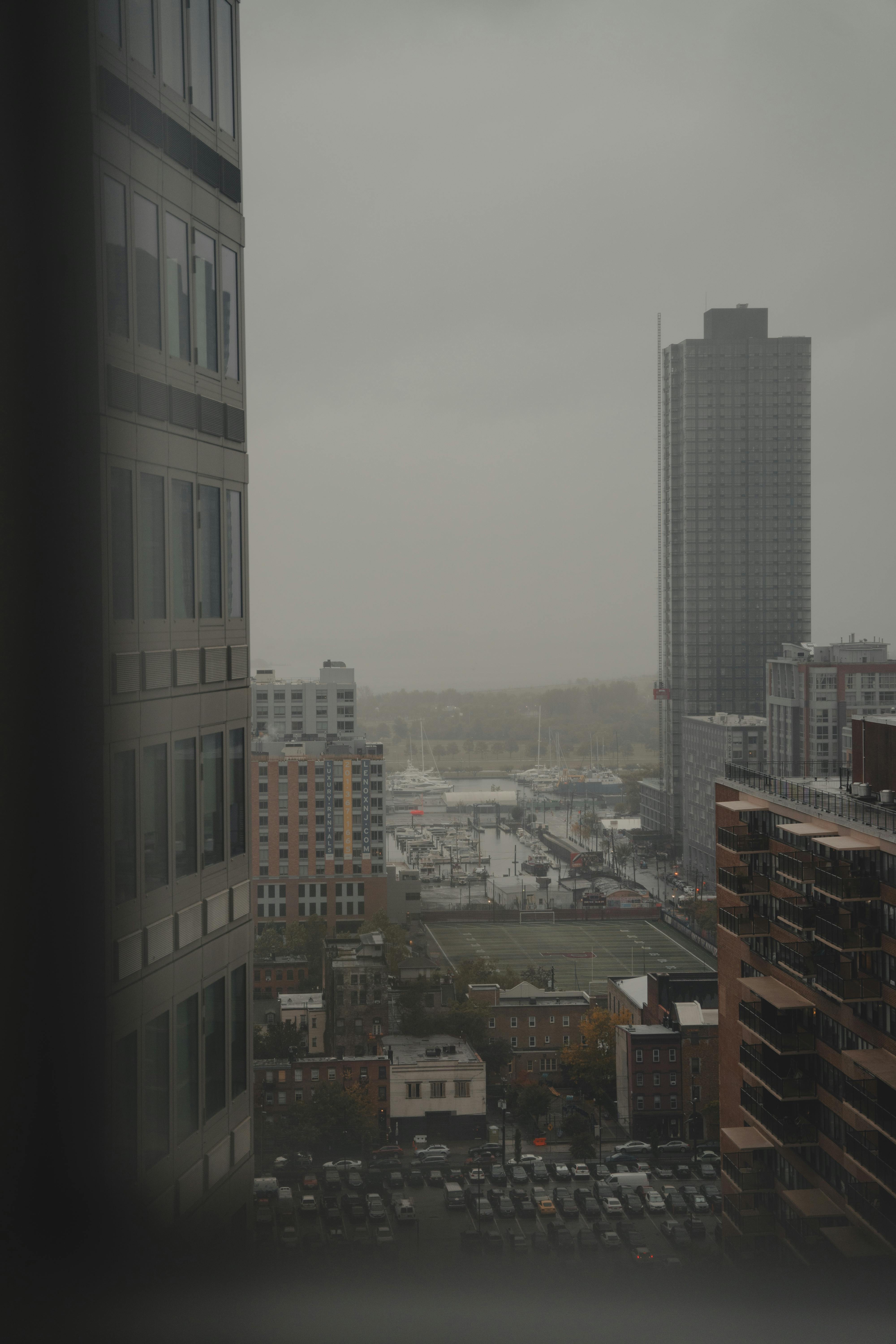 Gray Concrete Buildings Under Cloudy Sky · Free Stock Photo