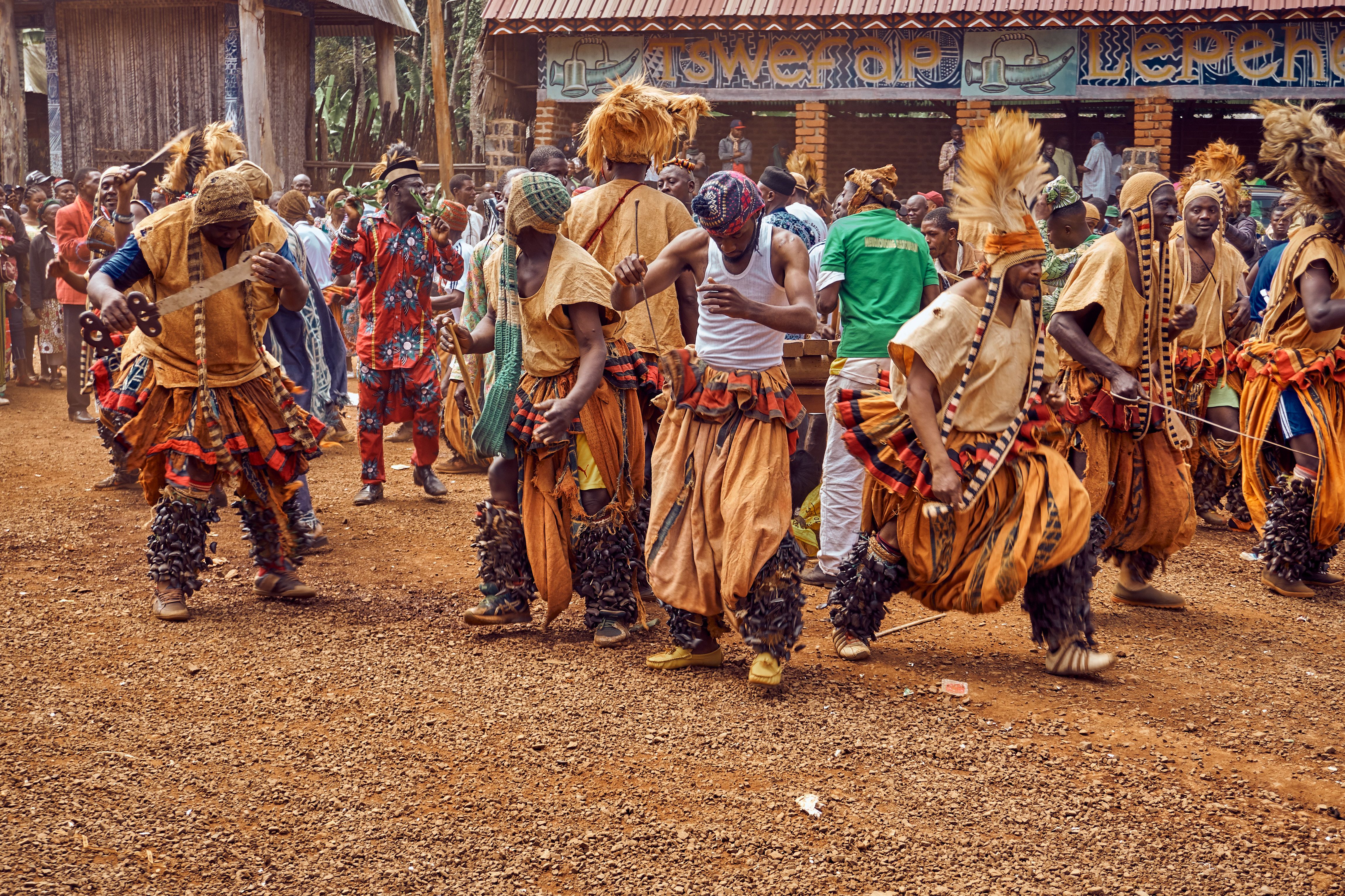 People in Traditional Dress Dancing on Brown Field · Free Stock Photo