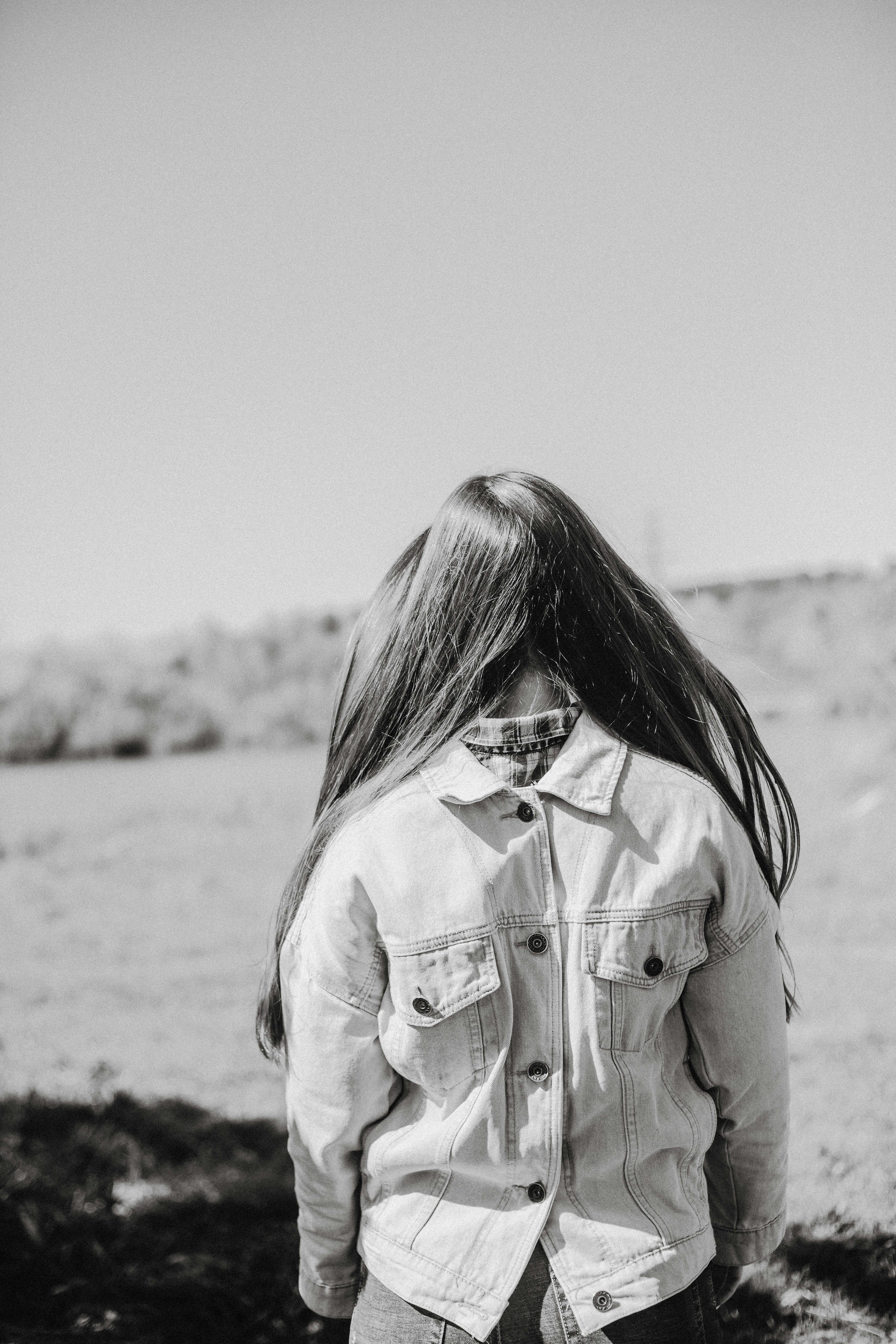 Grayscale Photo of a Person Wearing Jacket Backwards · Free Stock Photo