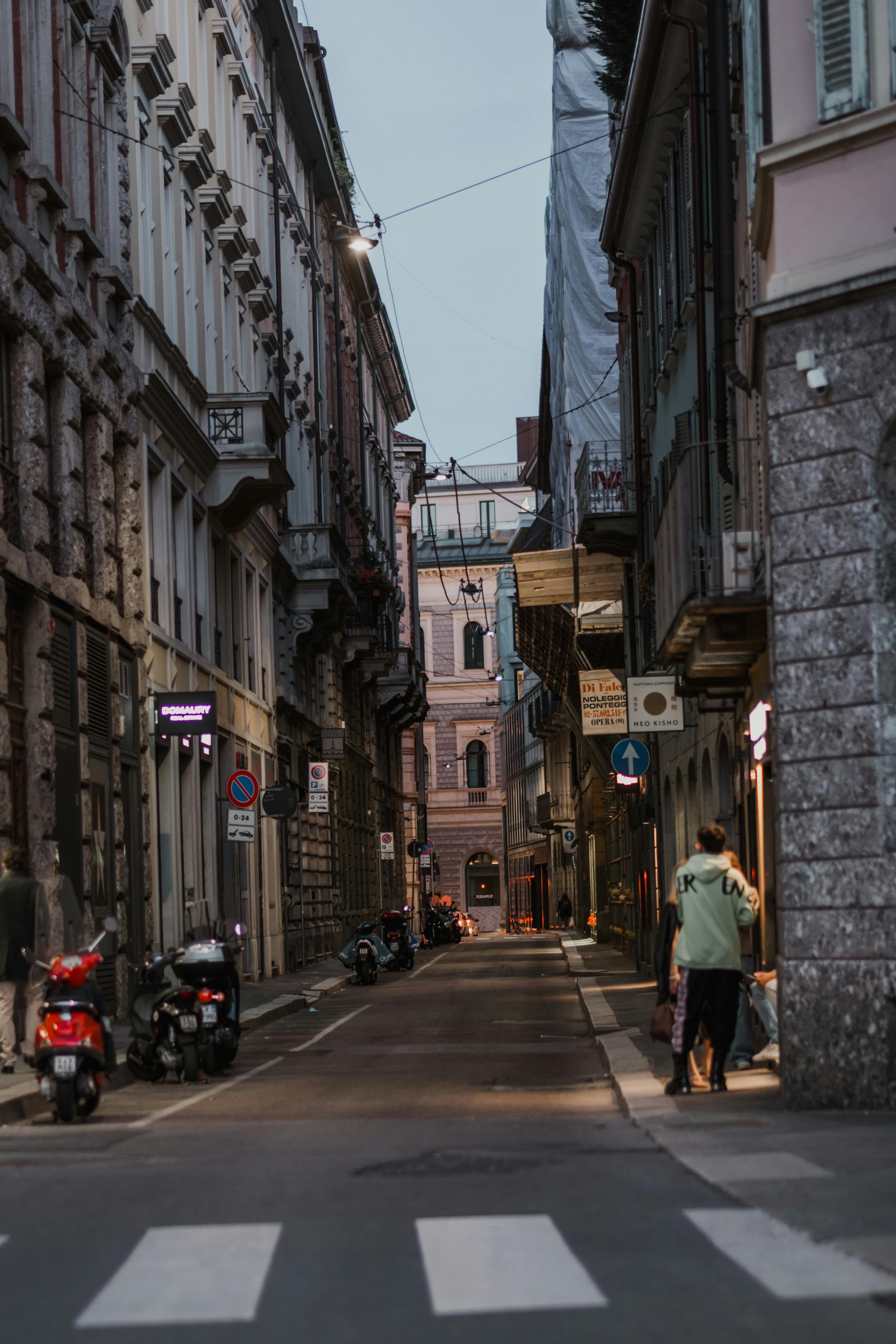 A Person Standing on the Street Between Buildings · Free Stock Photo