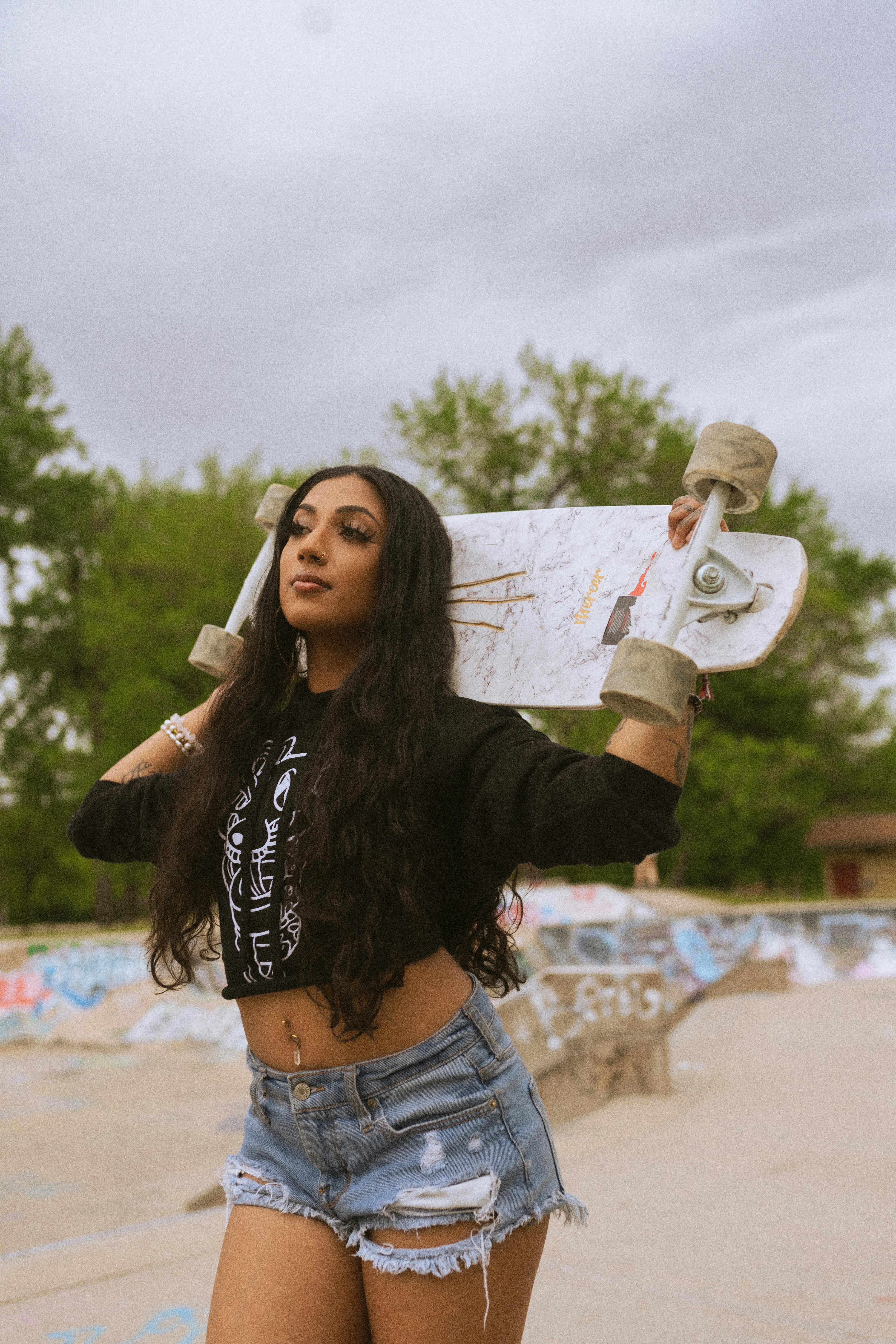 Woman Posing with Skateboard · Free Stock Photo